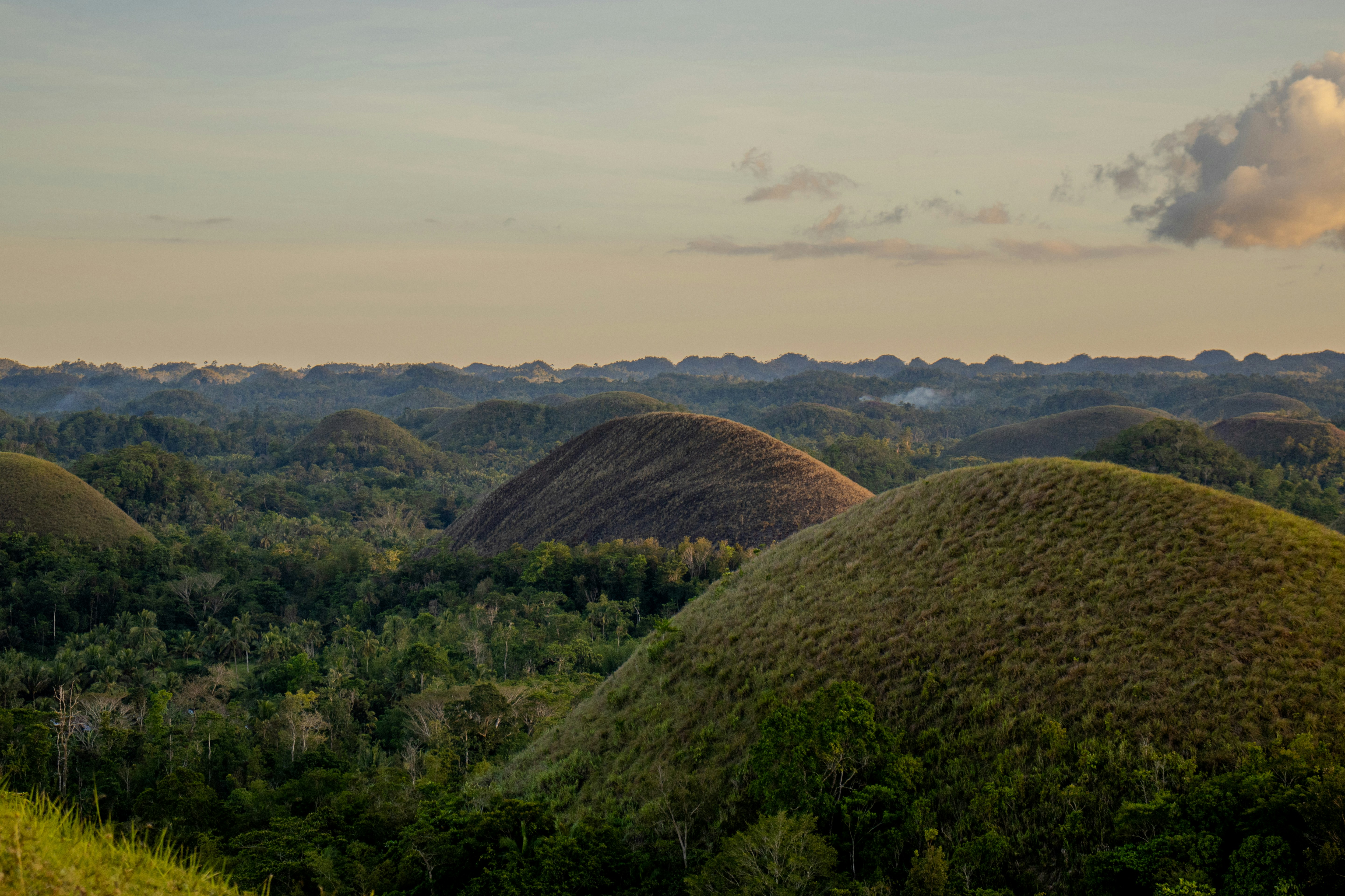 Undulating Hills of Chocolate Earth Under a Painted Sky