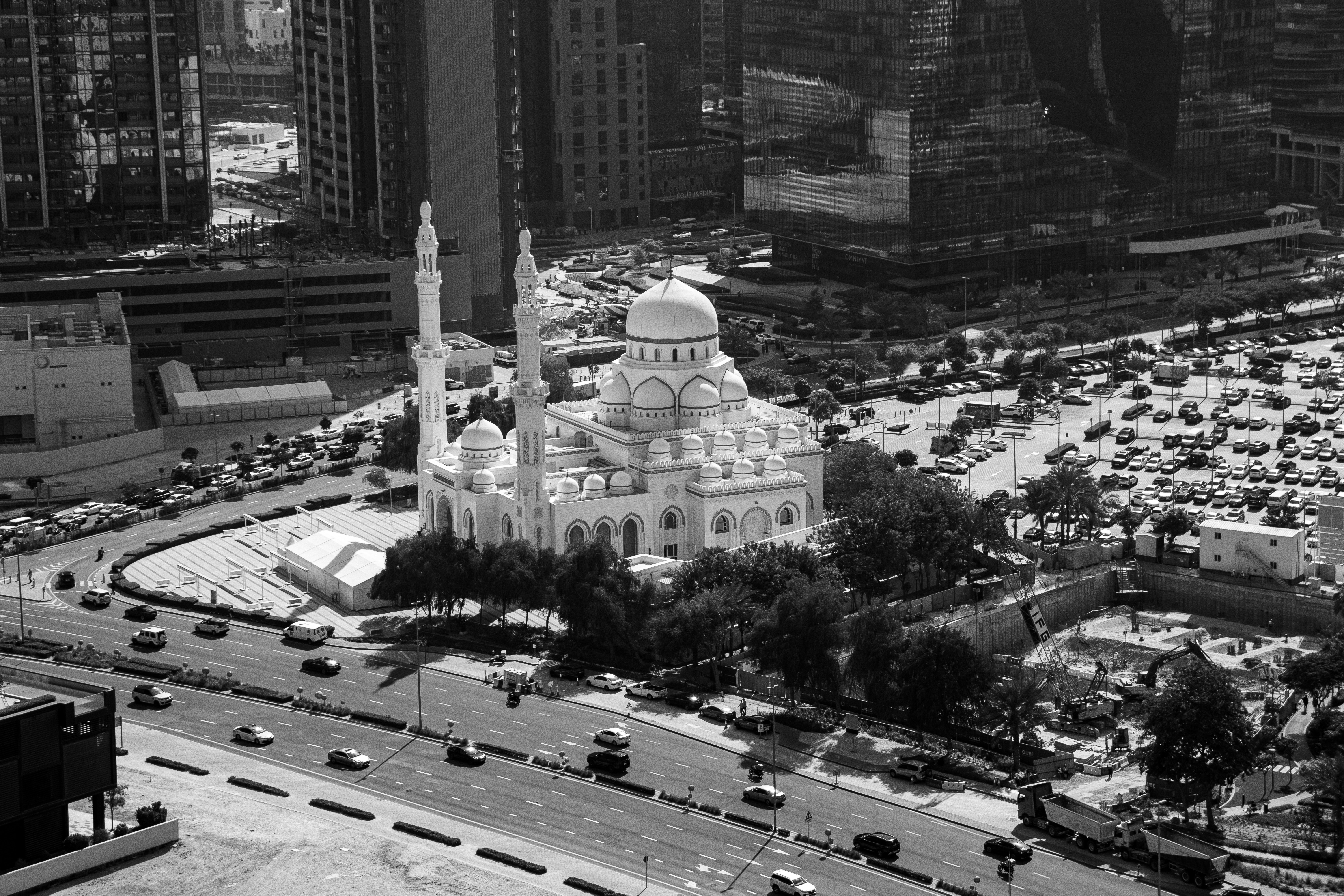 White Mosque Rising Above a Busy Urban Grid