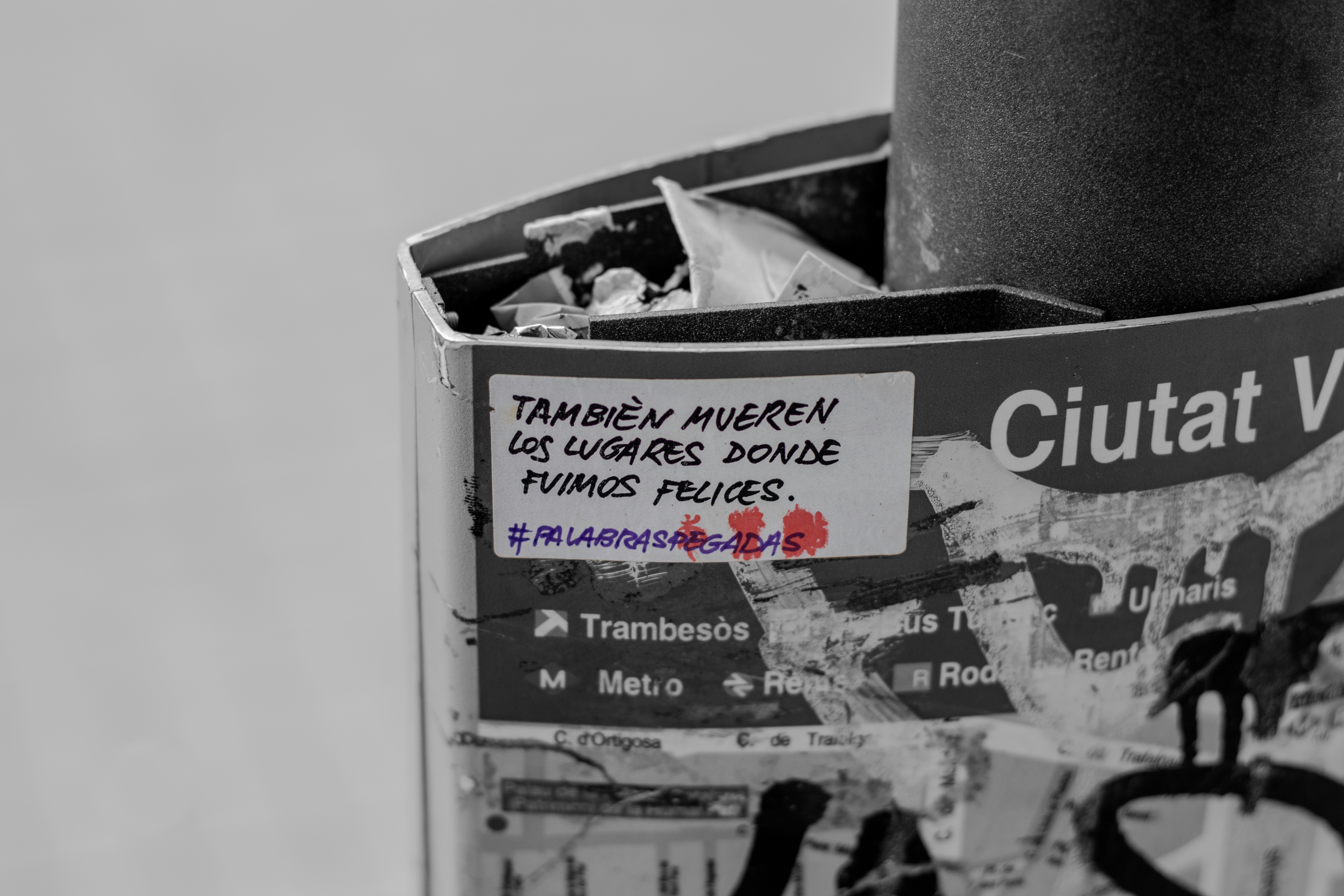 Urban imprint: a weathered bus shelter poster in grayscale