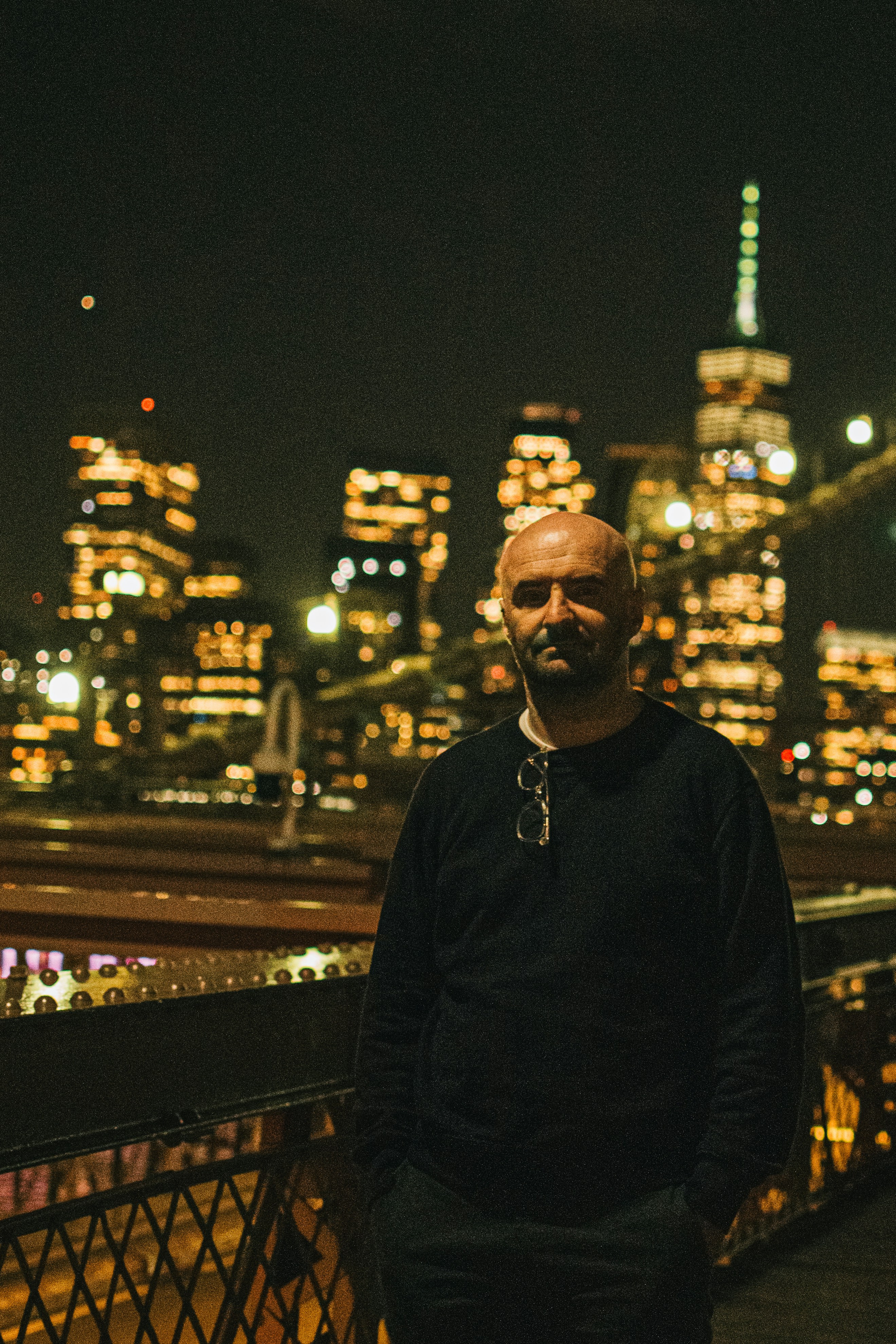 Nightscape Portrait on the Brooklyn Bridge: A Quiet Figure Beneath City Lights