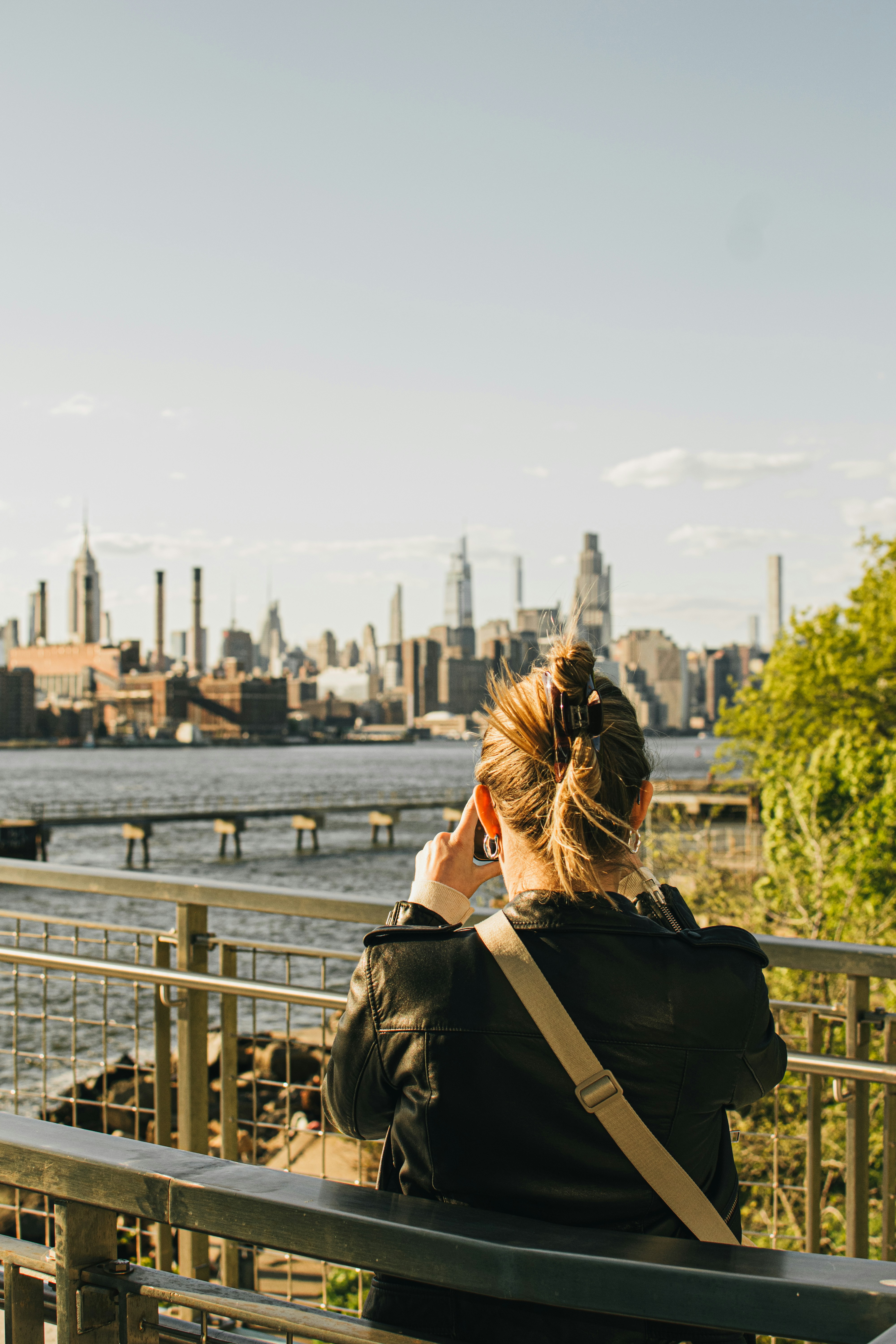 Portrait over the Water: A City Skyline Framed by a Backlit Moment