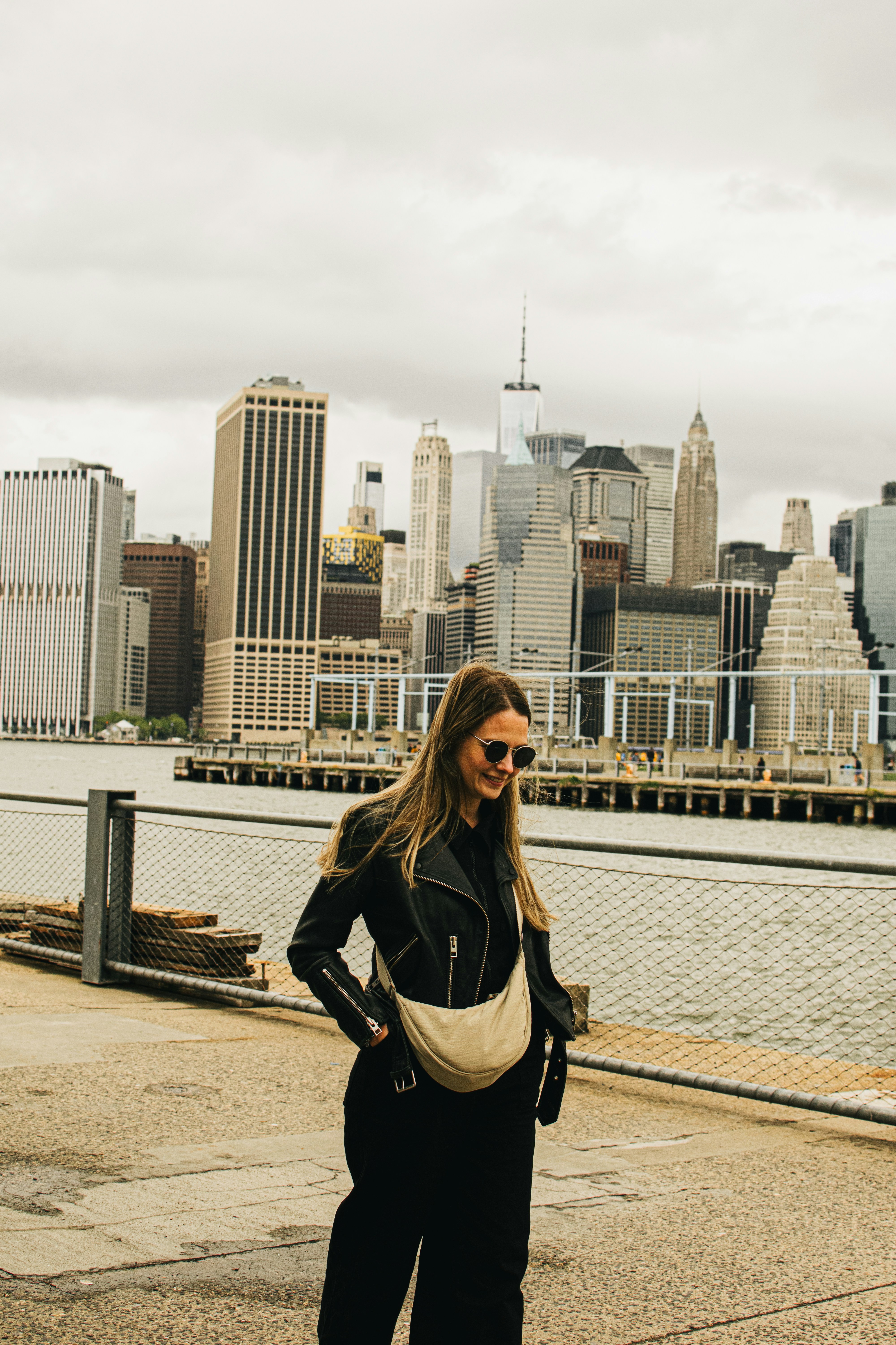 Cityfront Portrait: A Woman by the River with Skyline Backdrop