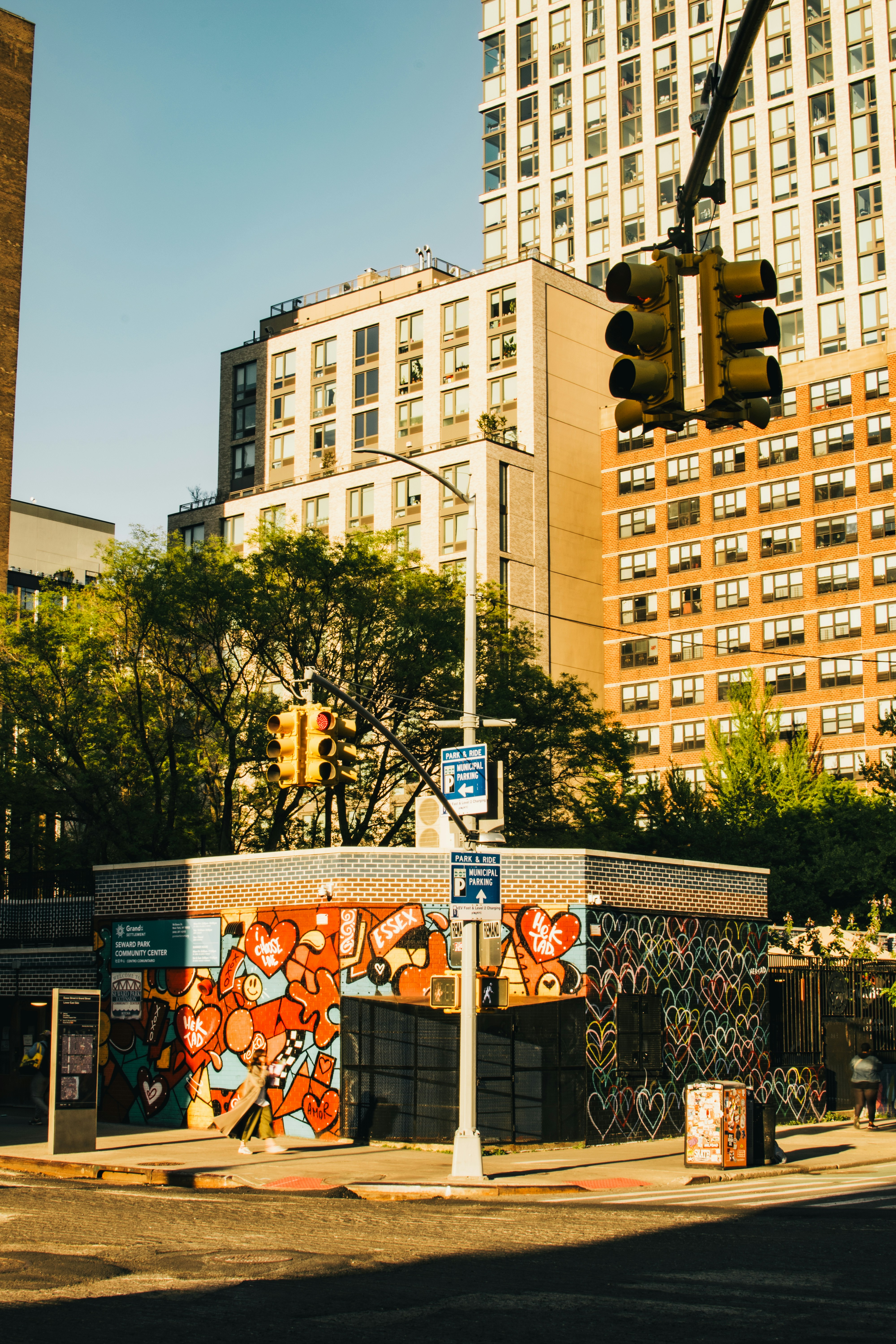 Urban graffiti kiosk under a cityscape of glass and brick