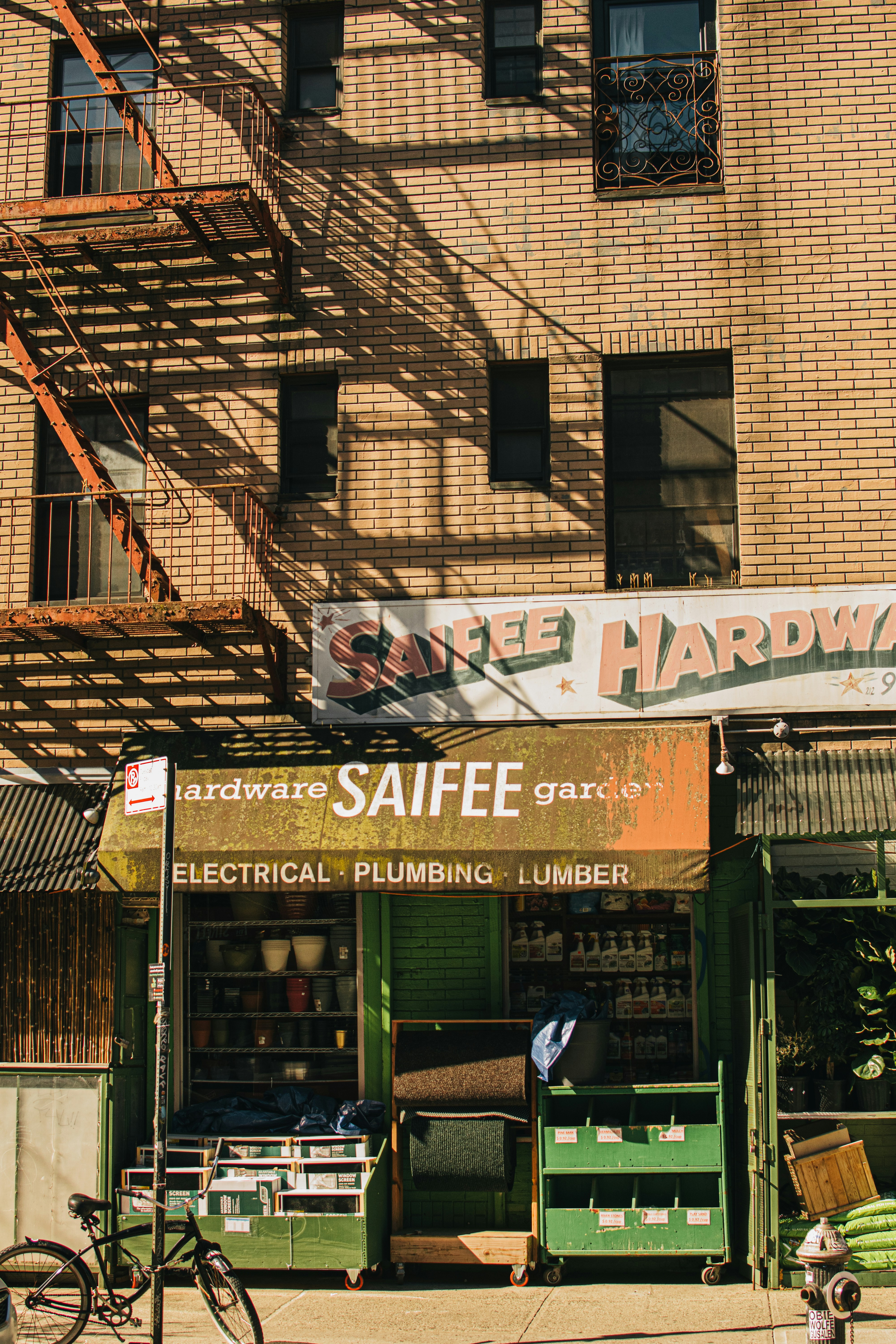 Sunlit Fire Escape Overhang Above Saifee Hardware