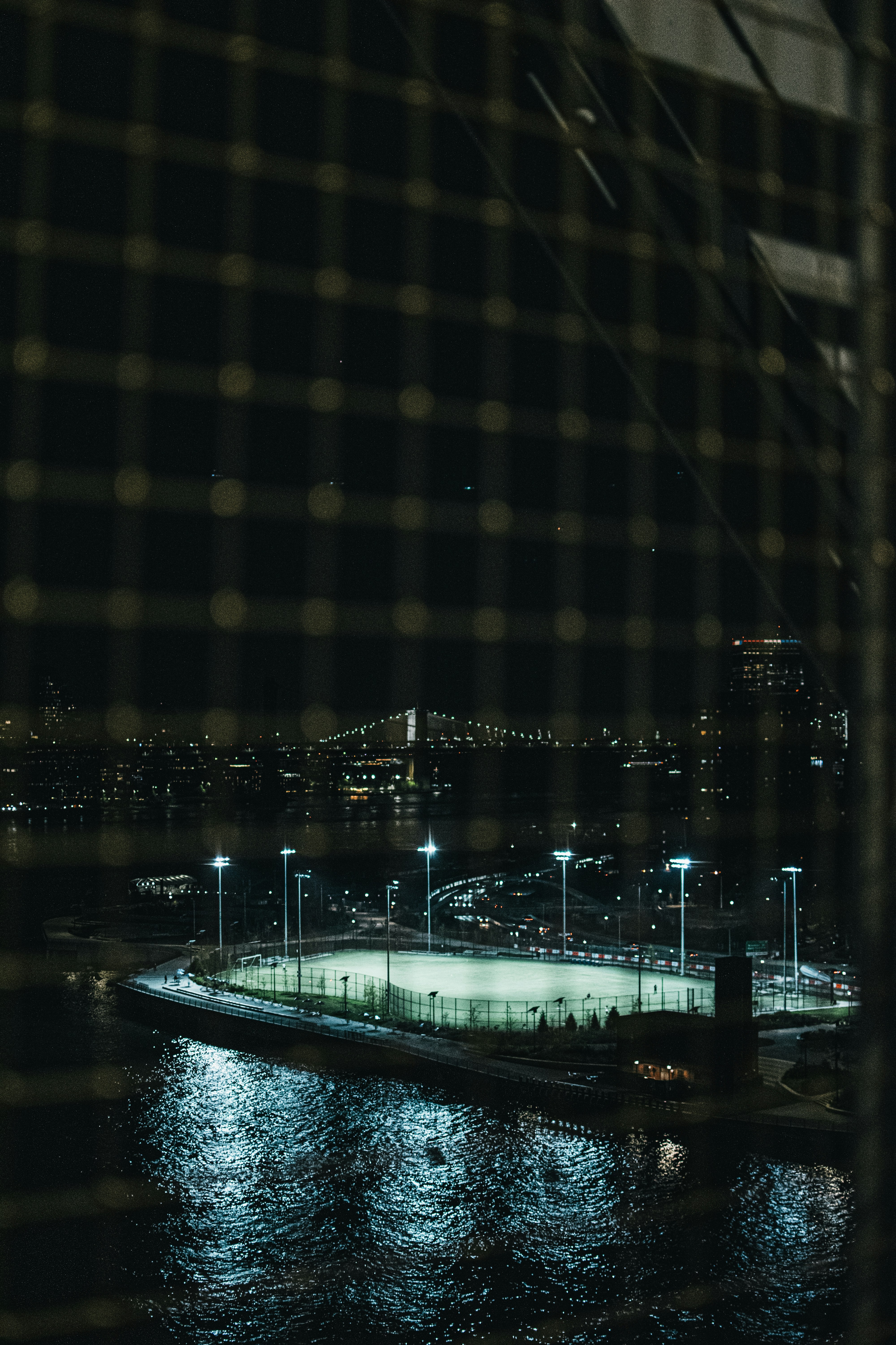Night Waterfront Sport Field Under City Lights