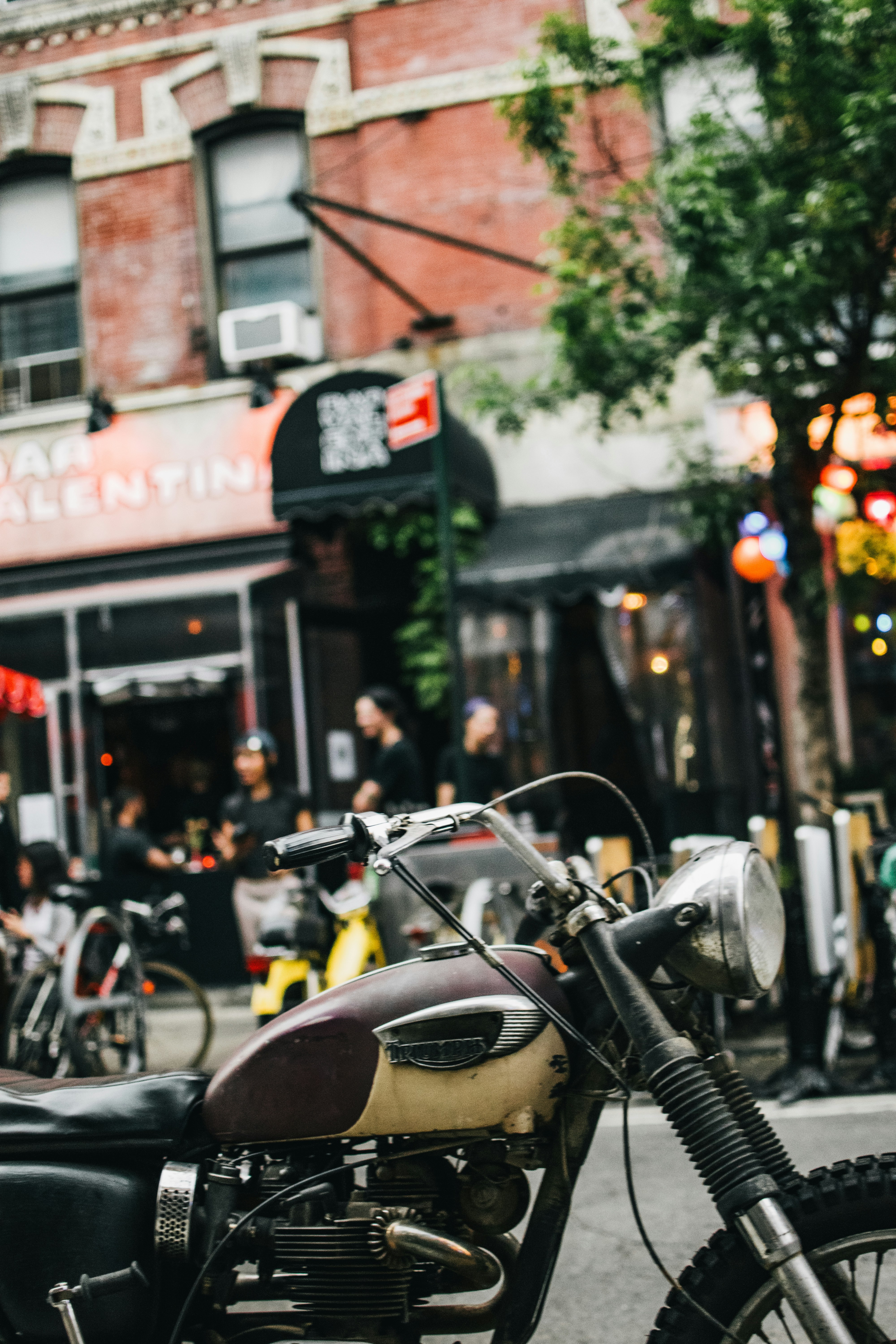 Streetfront Ride: A Vintage Motorcycle Anchors a Bustling NYC Block