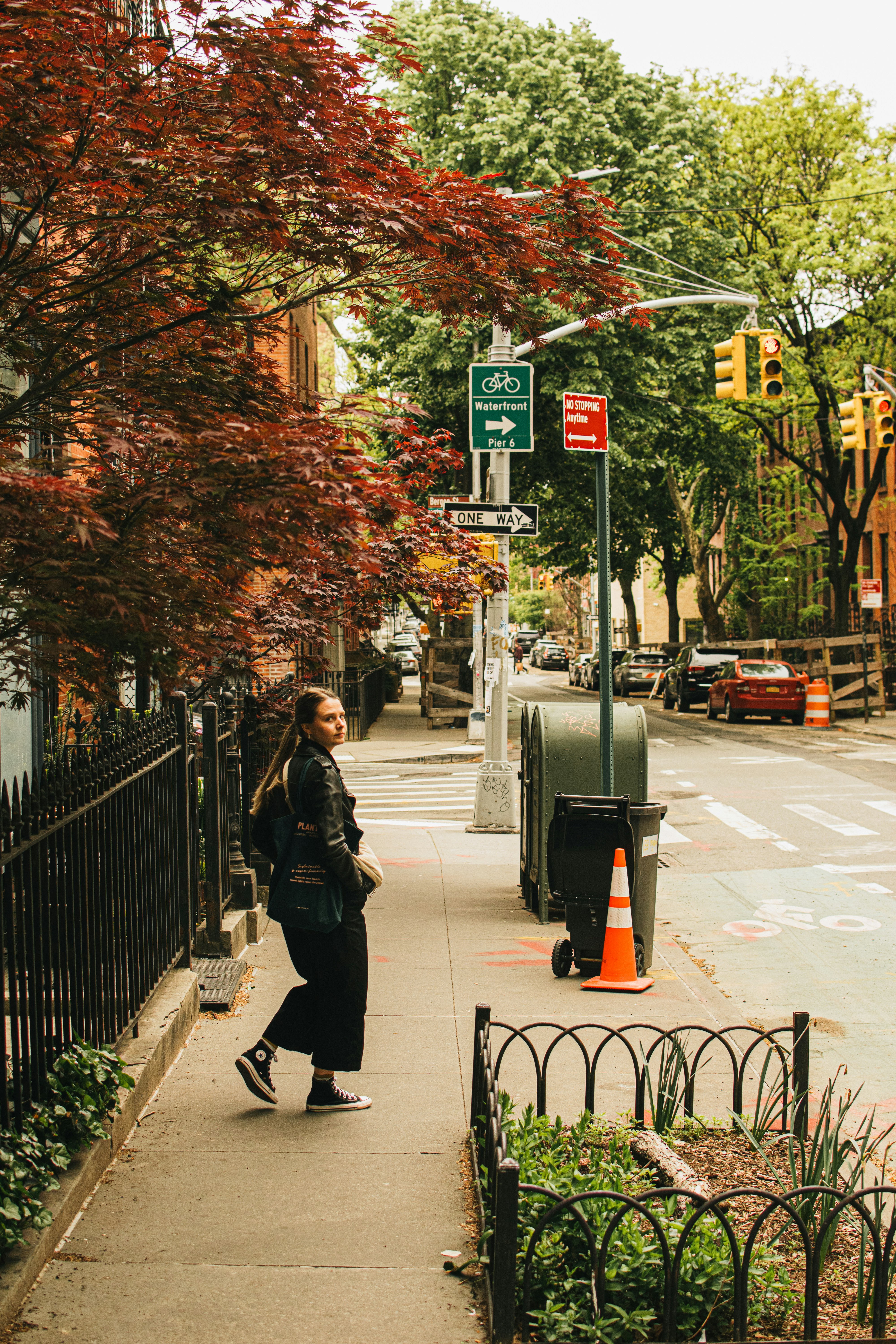 City Sidewalk Moment: A Quiet Turn Under Autumn Shade