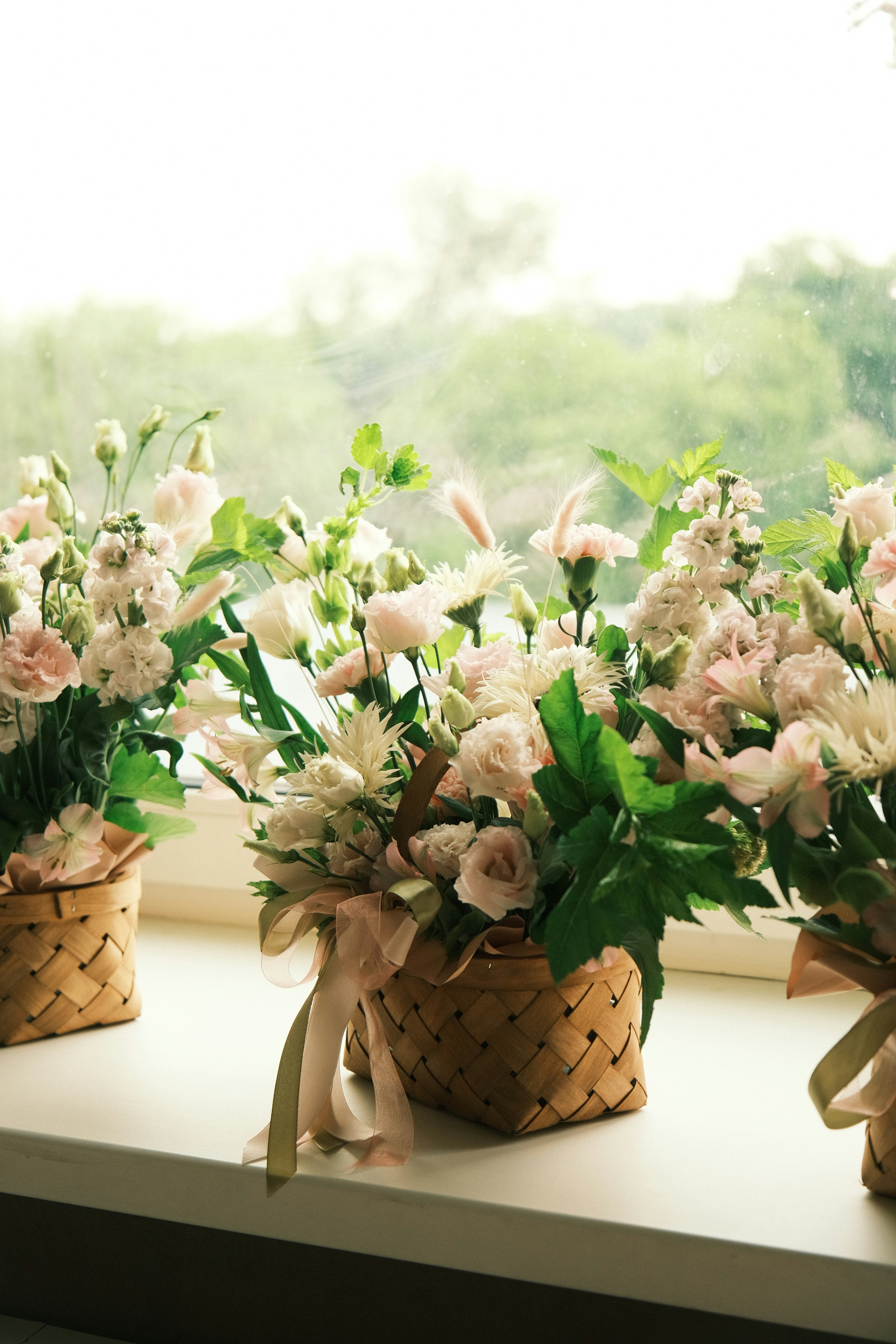 Soft Bloom on a Windowsill: Pale Peonies in Woven Baskets
