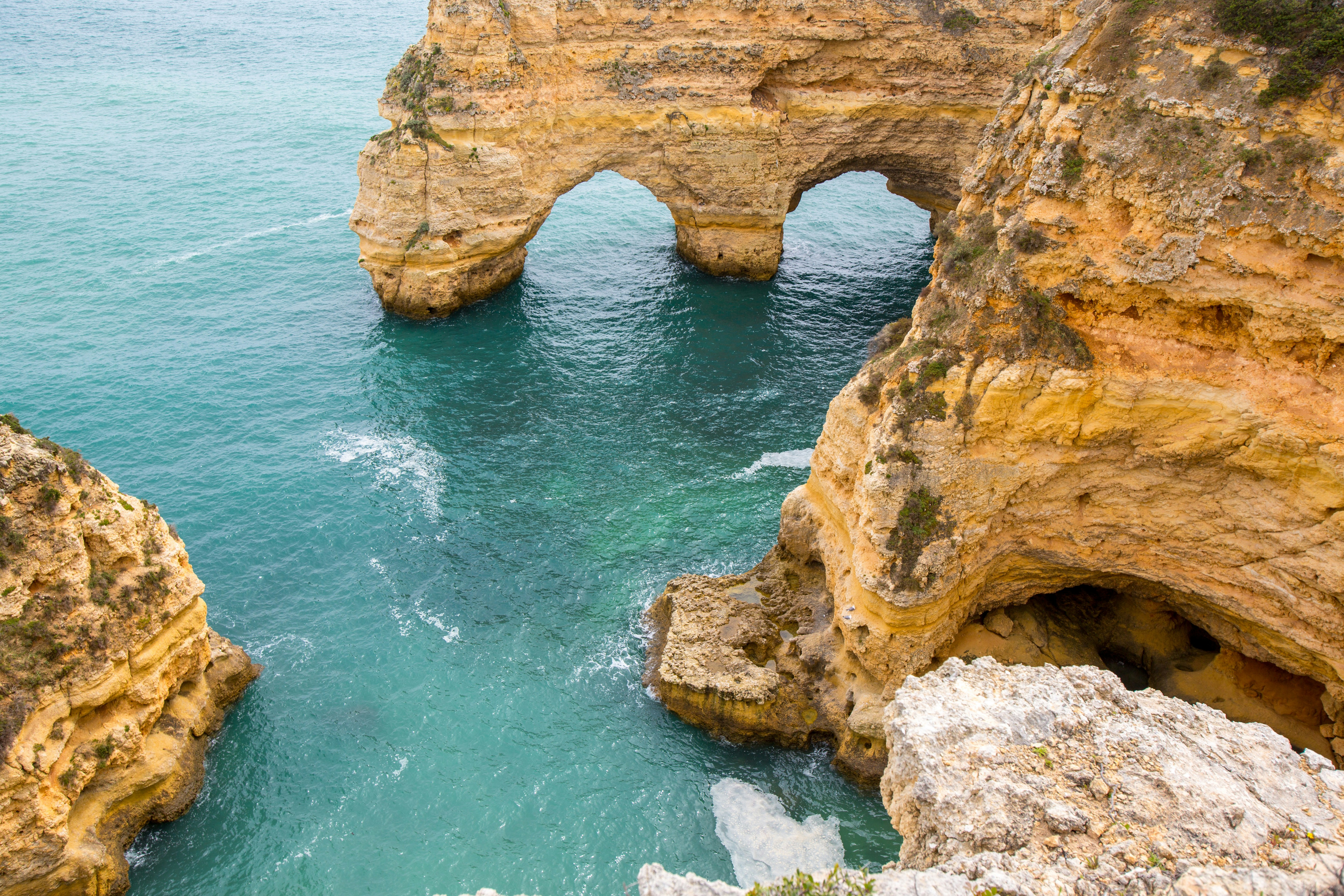 Sea Arches Beyond the Cliff: Golden Limestone and Turquoise Tides