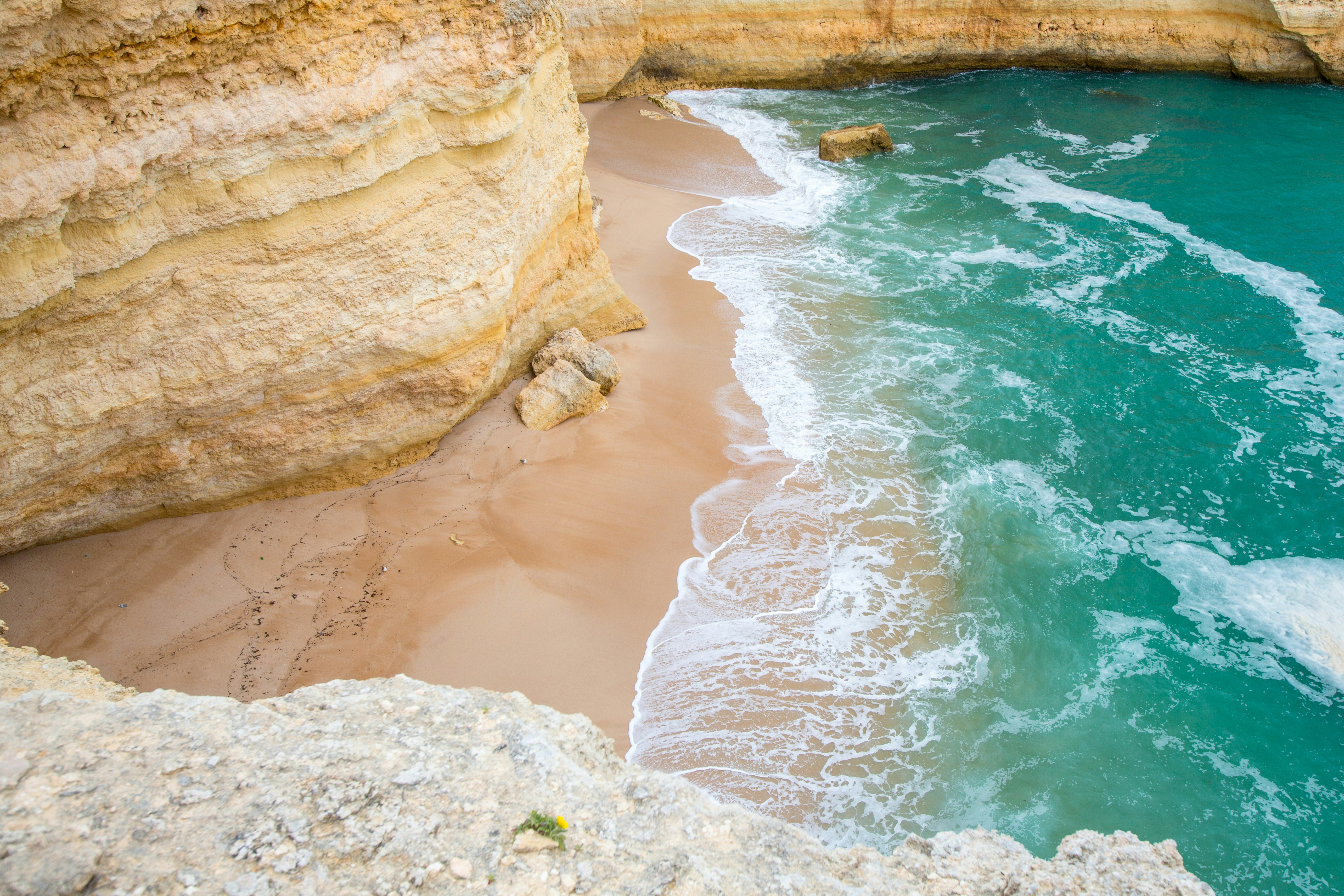 Cliffside Cove: Golden Sand Between Turquoise Waters