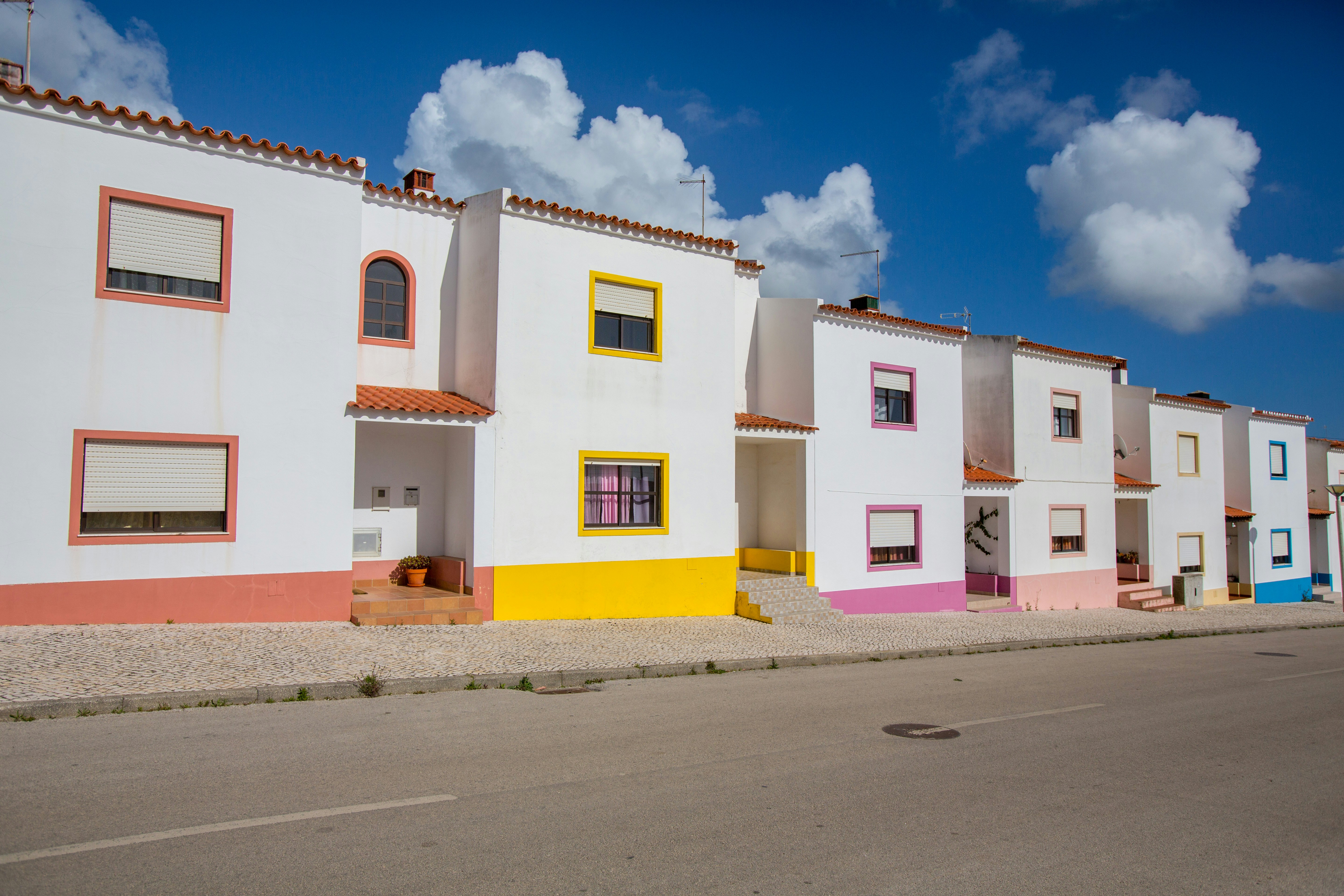 Chromatic row: pastel houses line a sunlit street