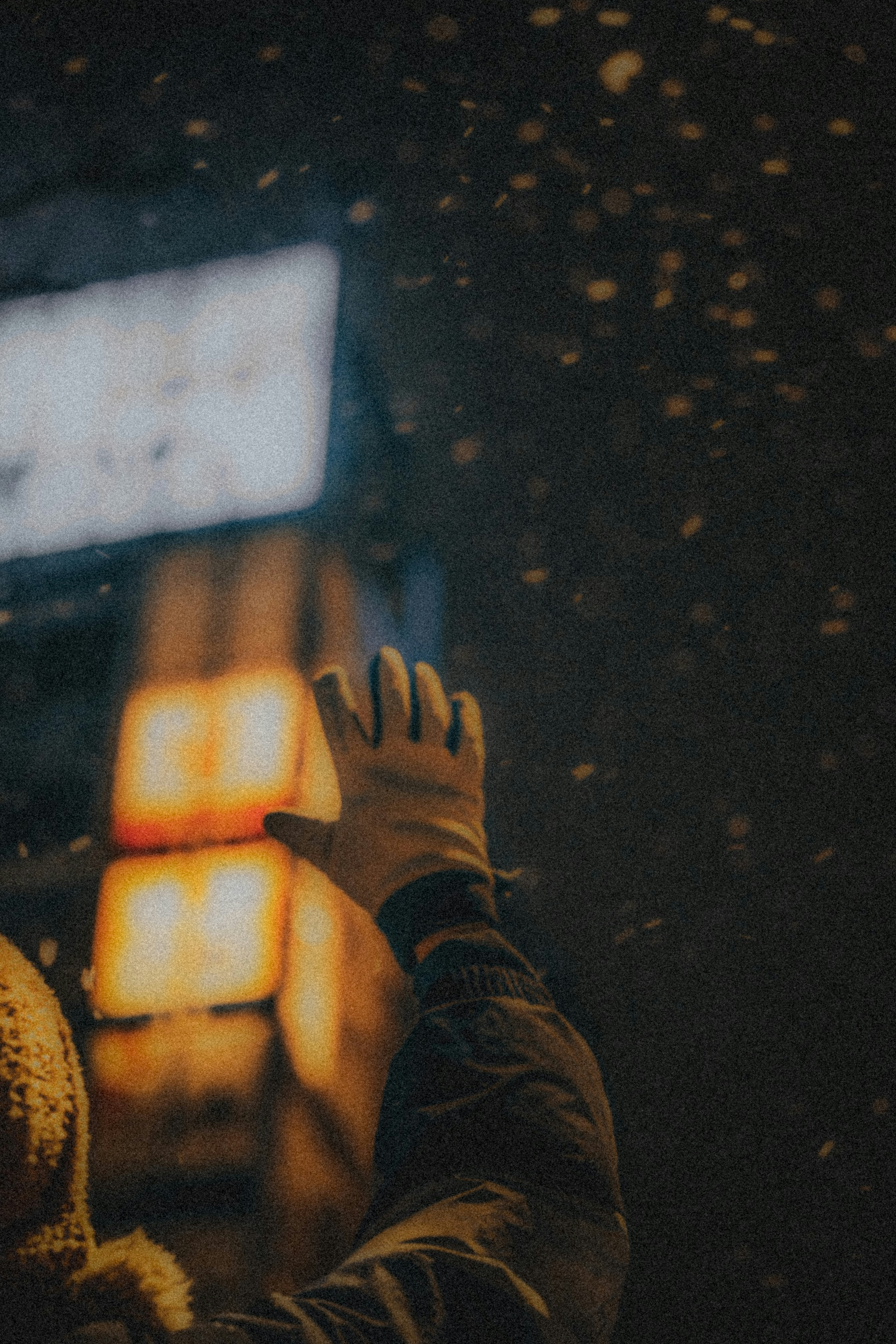 Hand Reaching Toward Warm Neon Echoes in Snow Night
