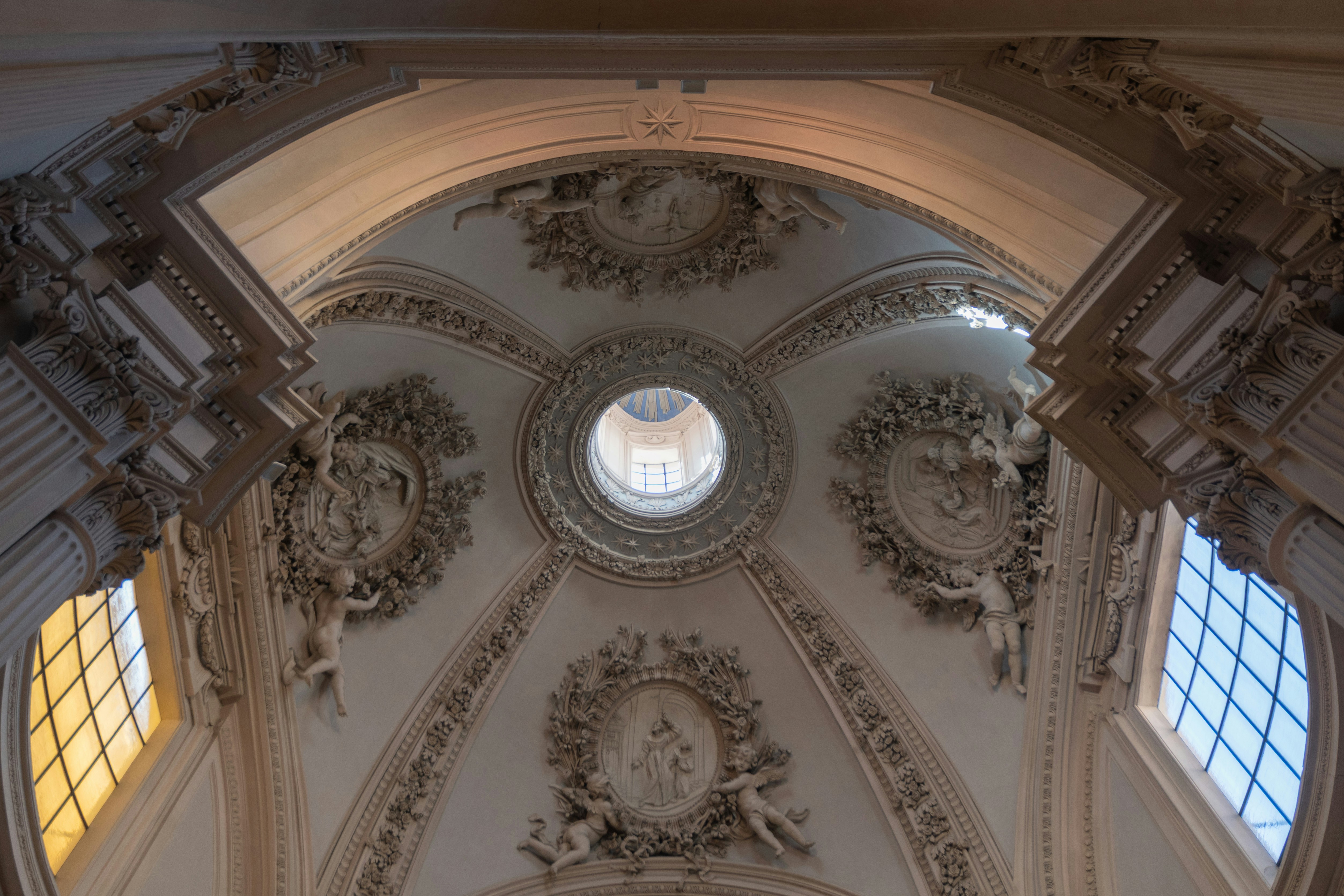 Ornate Dome Ceiling: Baroque Carvings and Central Oculous