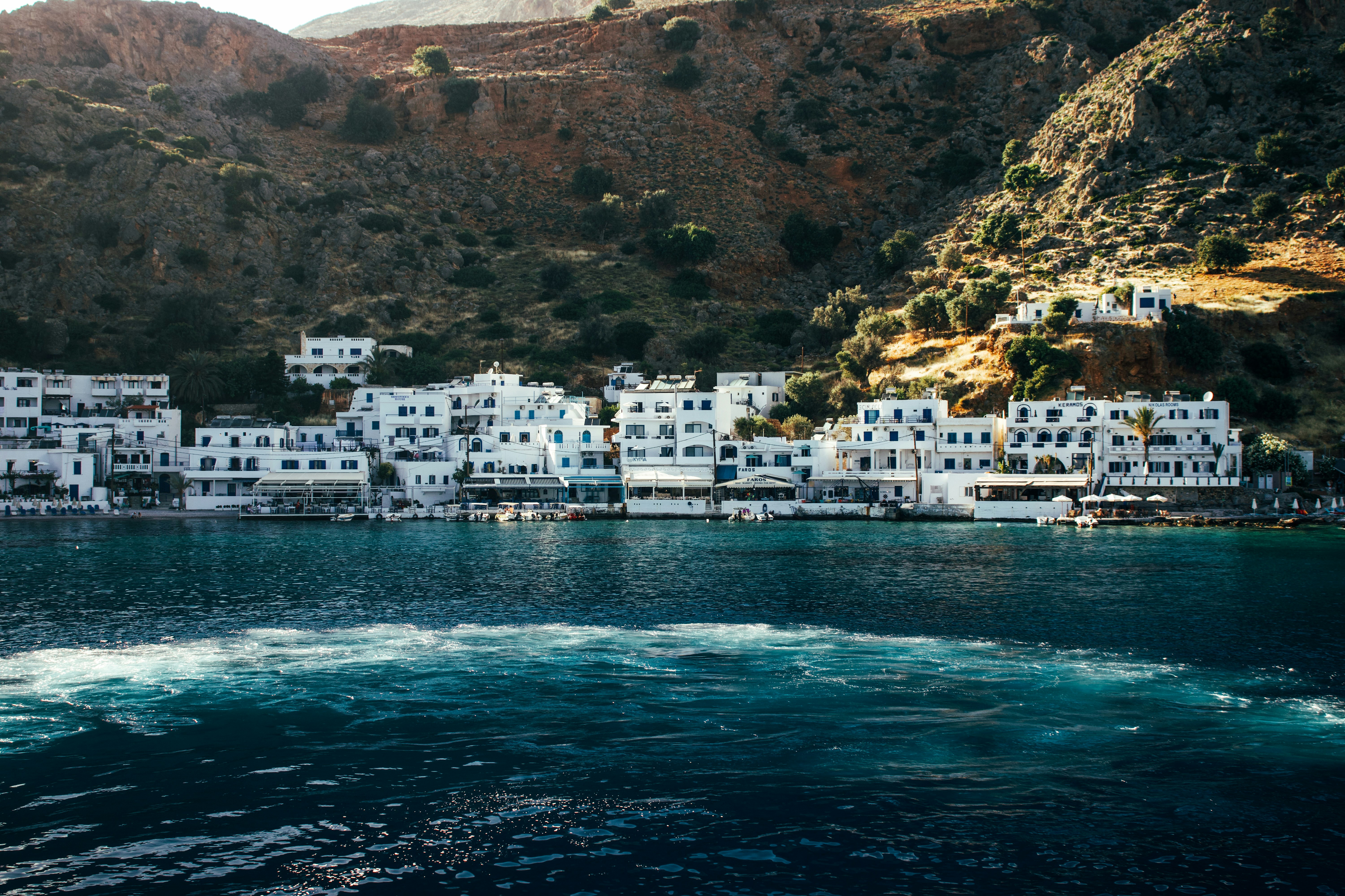 White-washed village along a serene Aegean harbor