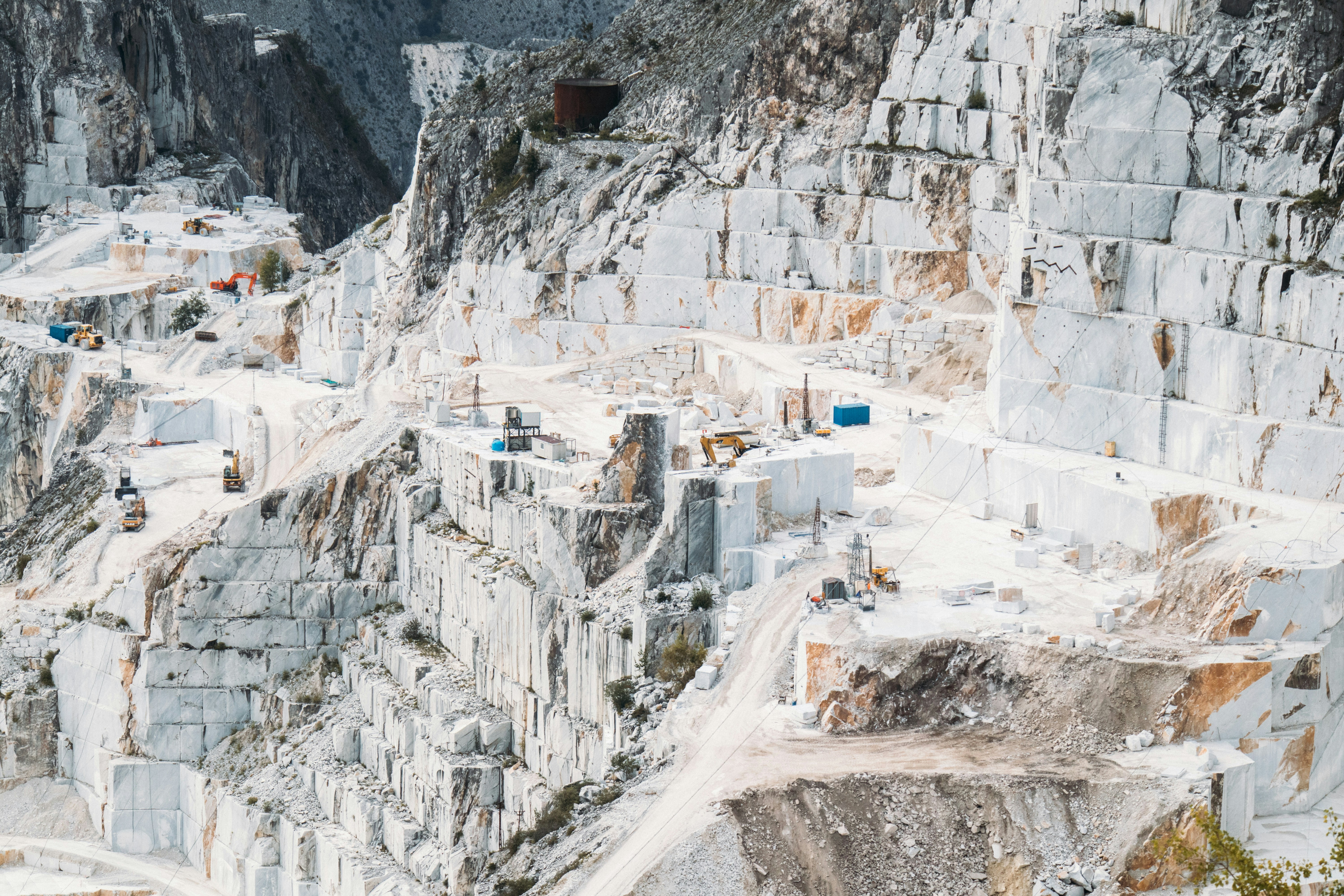 Sun-Scaled Quarry: Terraced Marble Giants Against Cliffside Skies