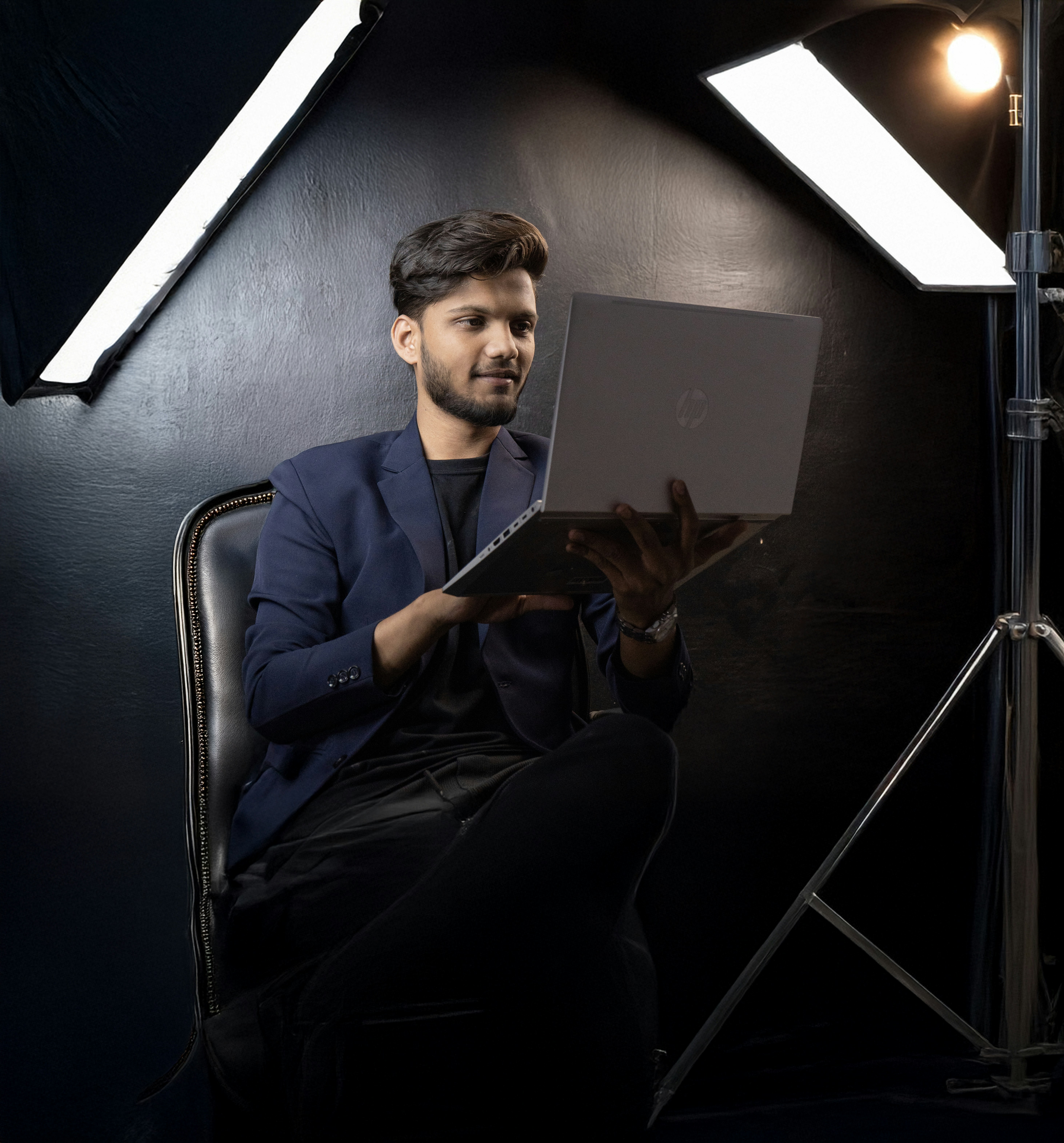 Focused in the Studio: A Confident Creator with Laptop in Hands