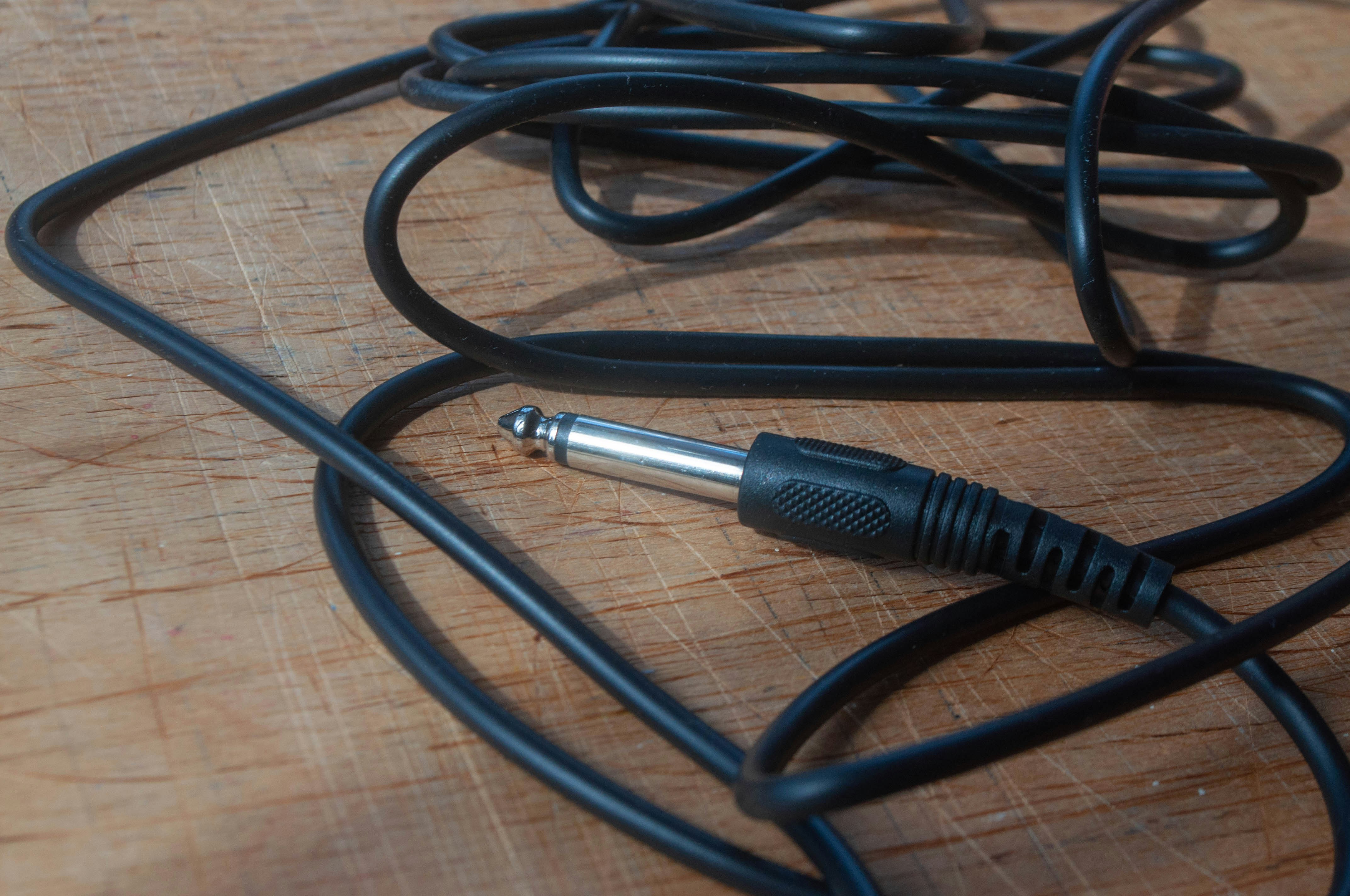 Tangled Cables on a Wooden Worksurface