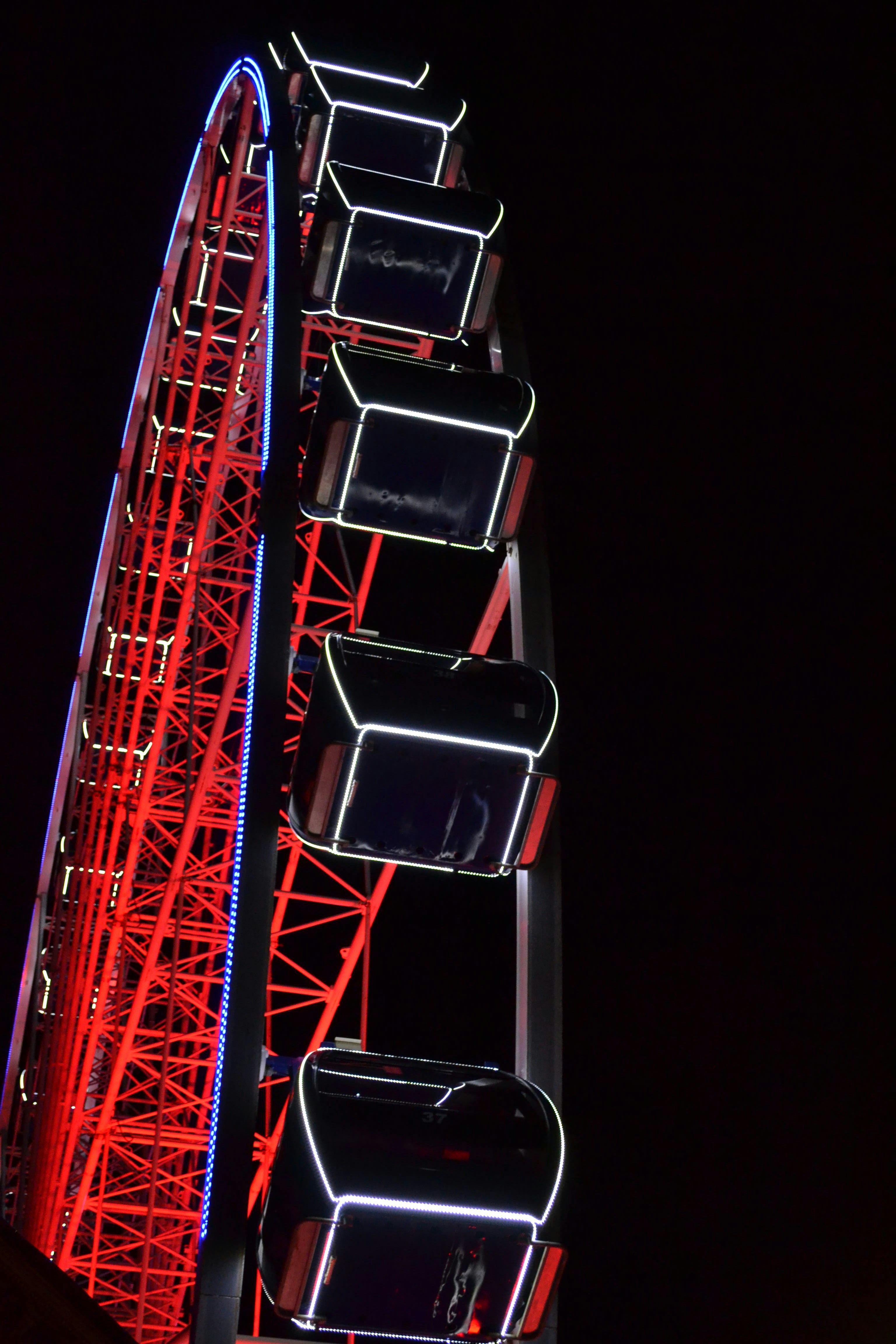 Neon Ferris Wheel Glow: A Night Ride in Red and Blue