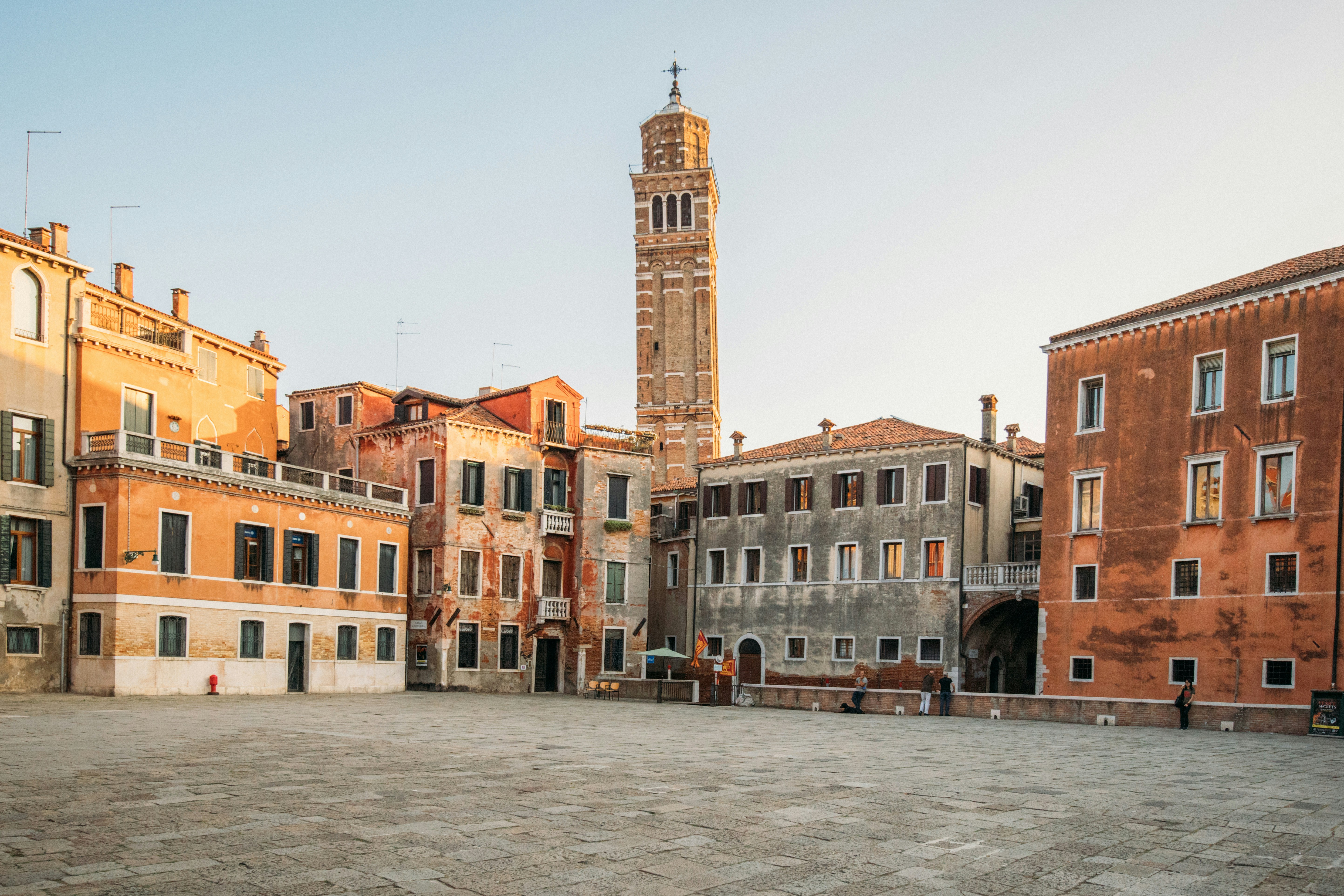 Sunlit Piazza with Bell Tower Rising Above Venetian Facades
