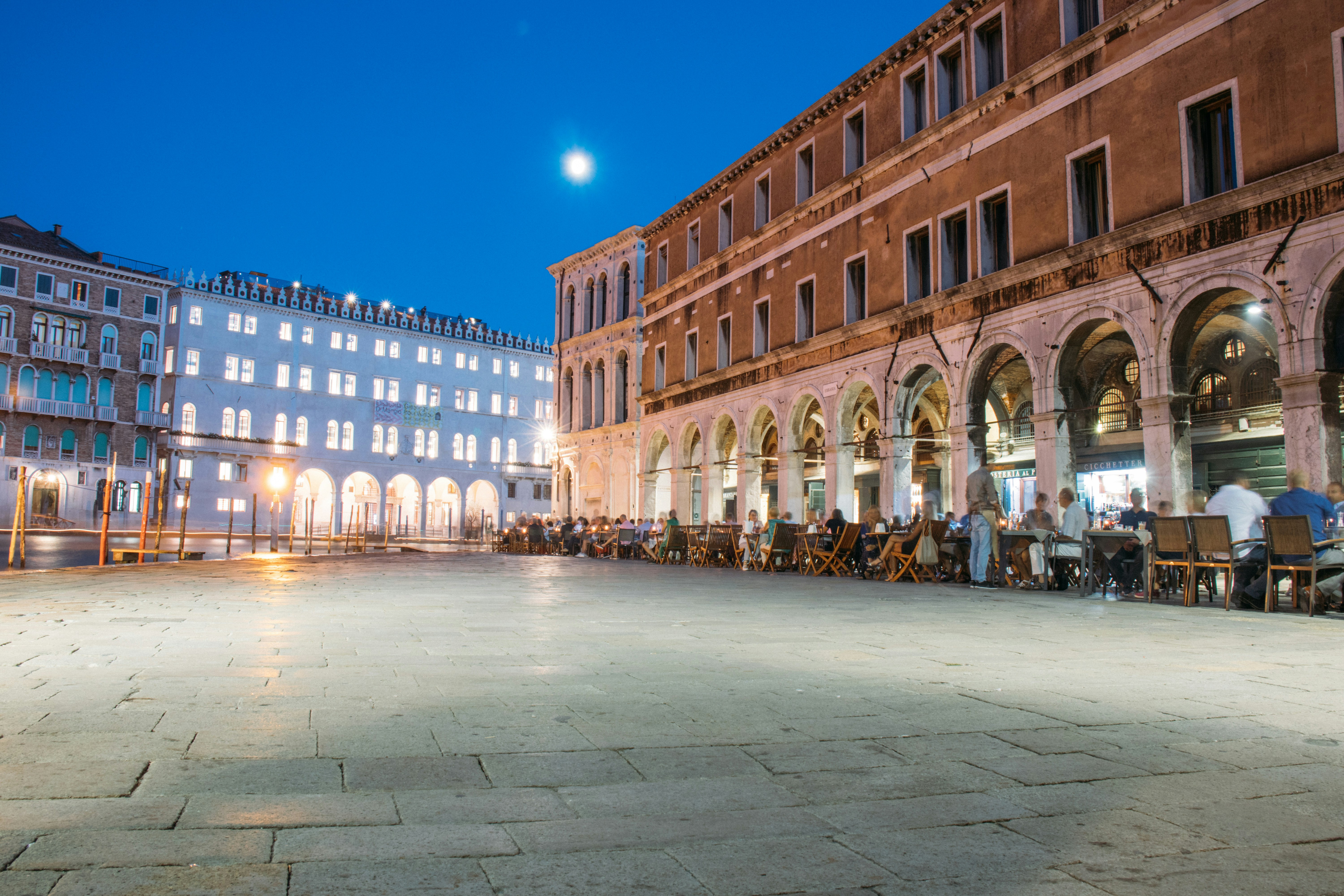 Evening Veranda: Café Lights by the Arched Facade