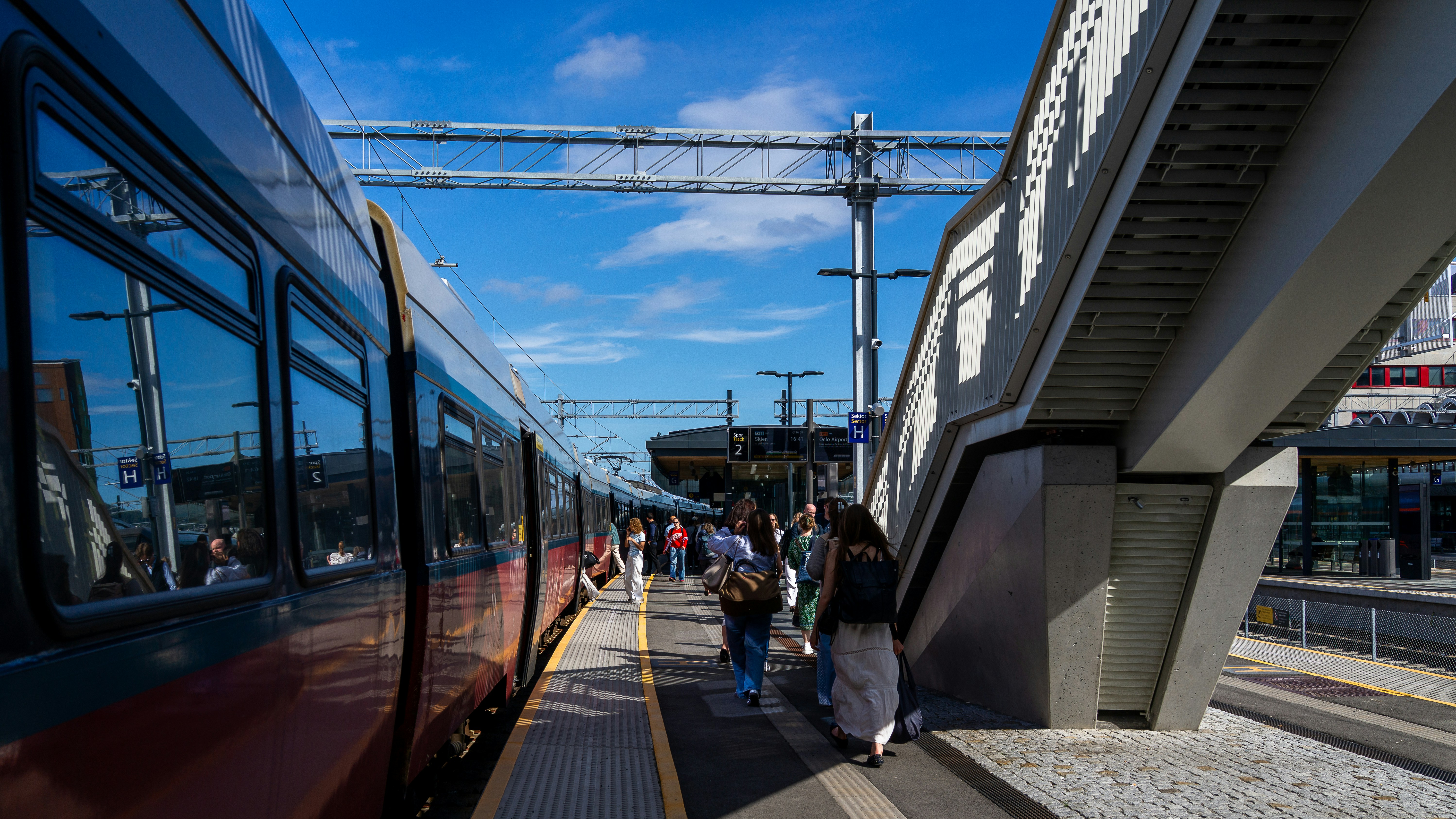 Platform Pulse: Commuters Converge Beneath a Steel Arc