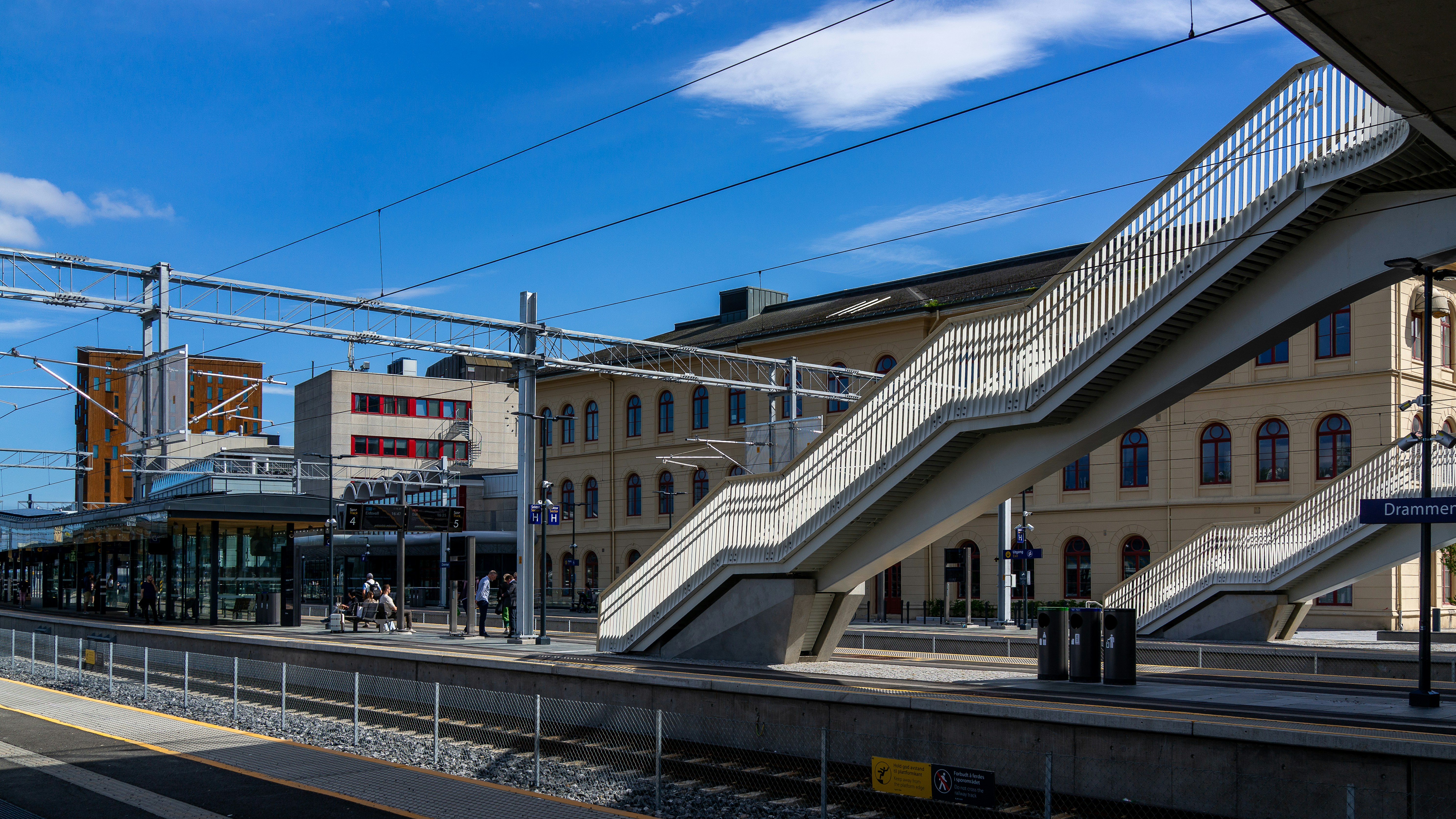 Concrete Ascent: Footbridge over a Quiet Rail Station
