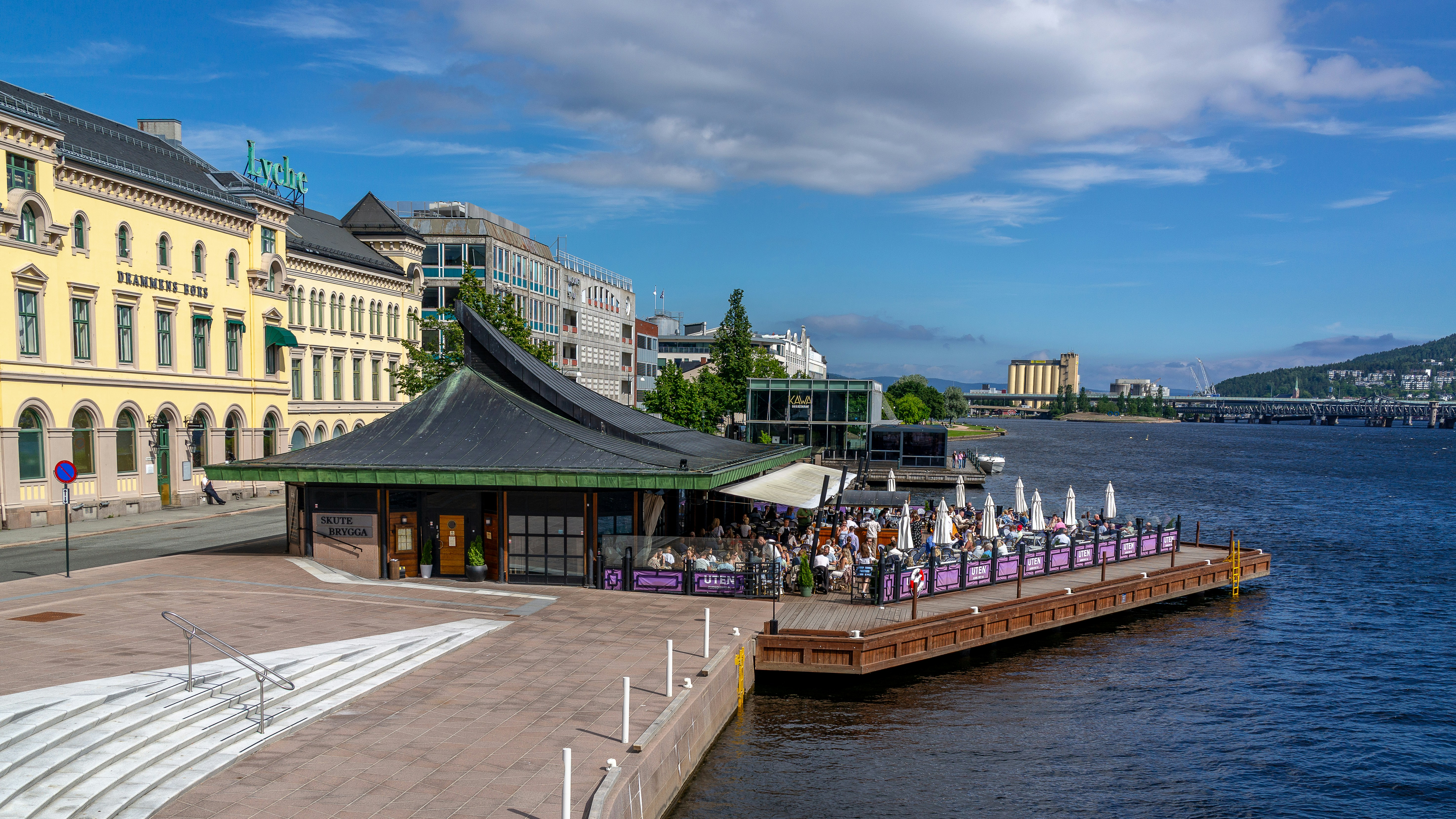 Lakeside Pavilion and promenade under a bright Nordic sky