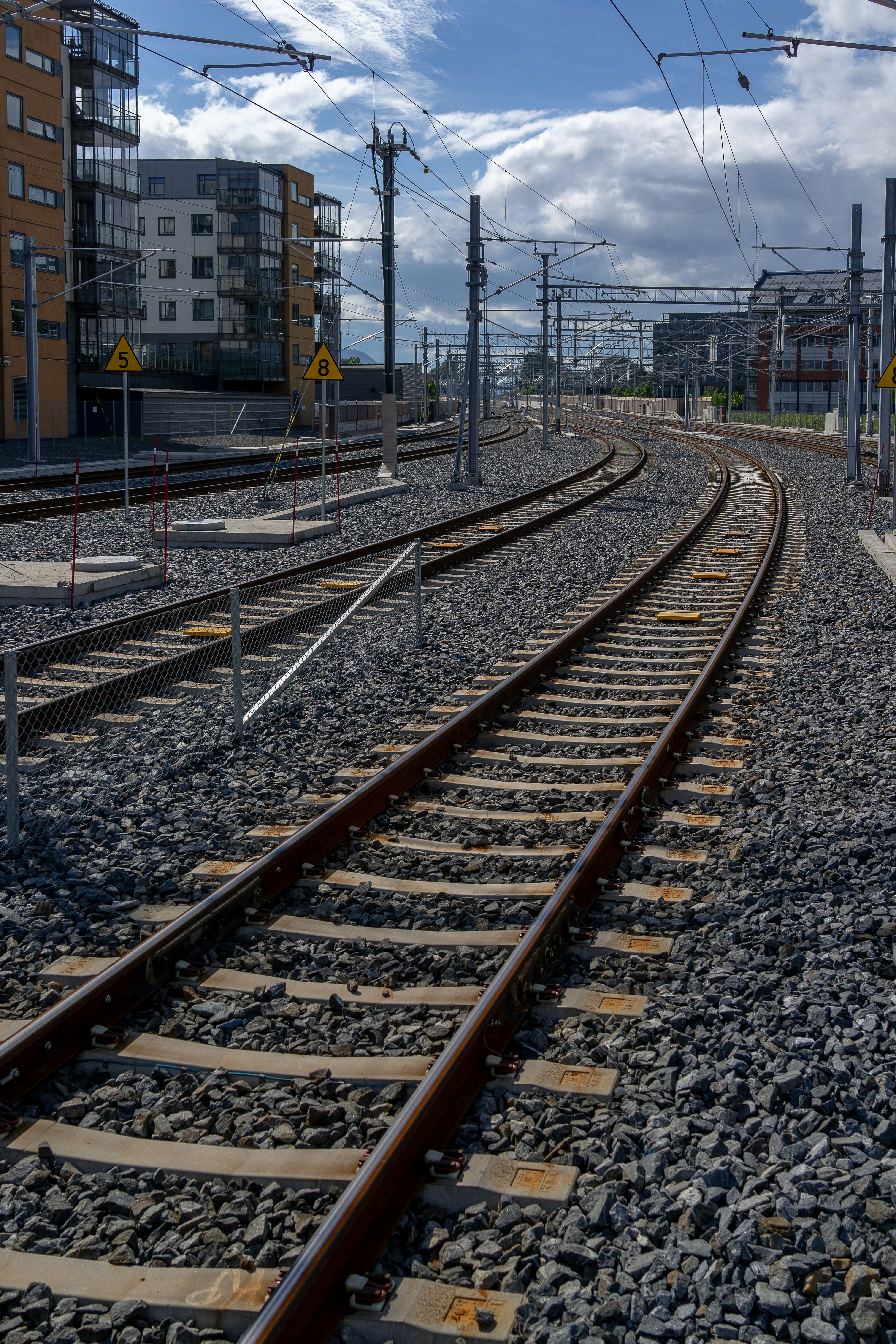 Rails into the Horizon: Modern Tracks and Urban Skyline