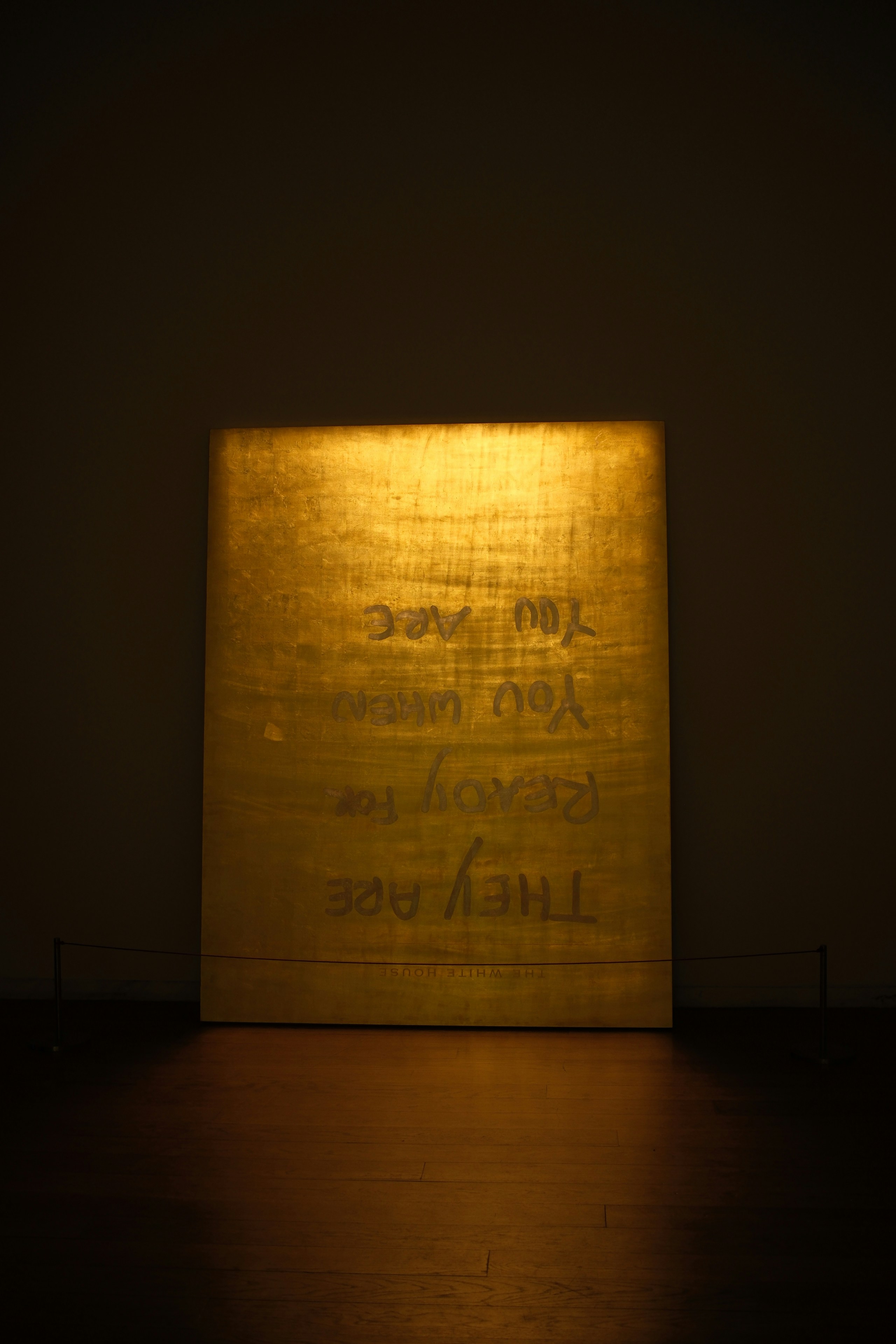 Gilded Backdrop, Whispered Words: An Upright Block Surrounded by Darkness