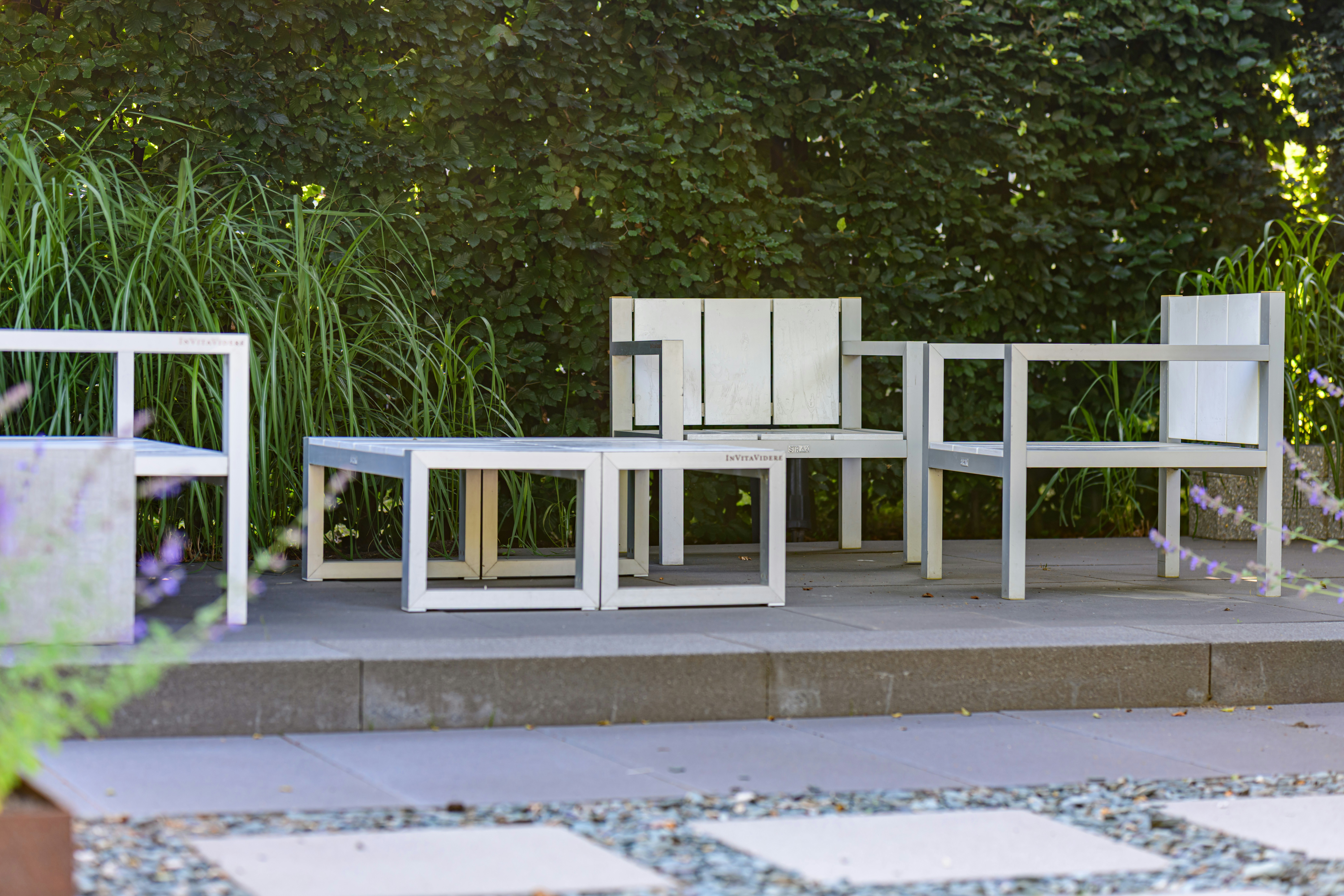 Minimalist White Lounge Ensemble Framed by Lush Greenery
