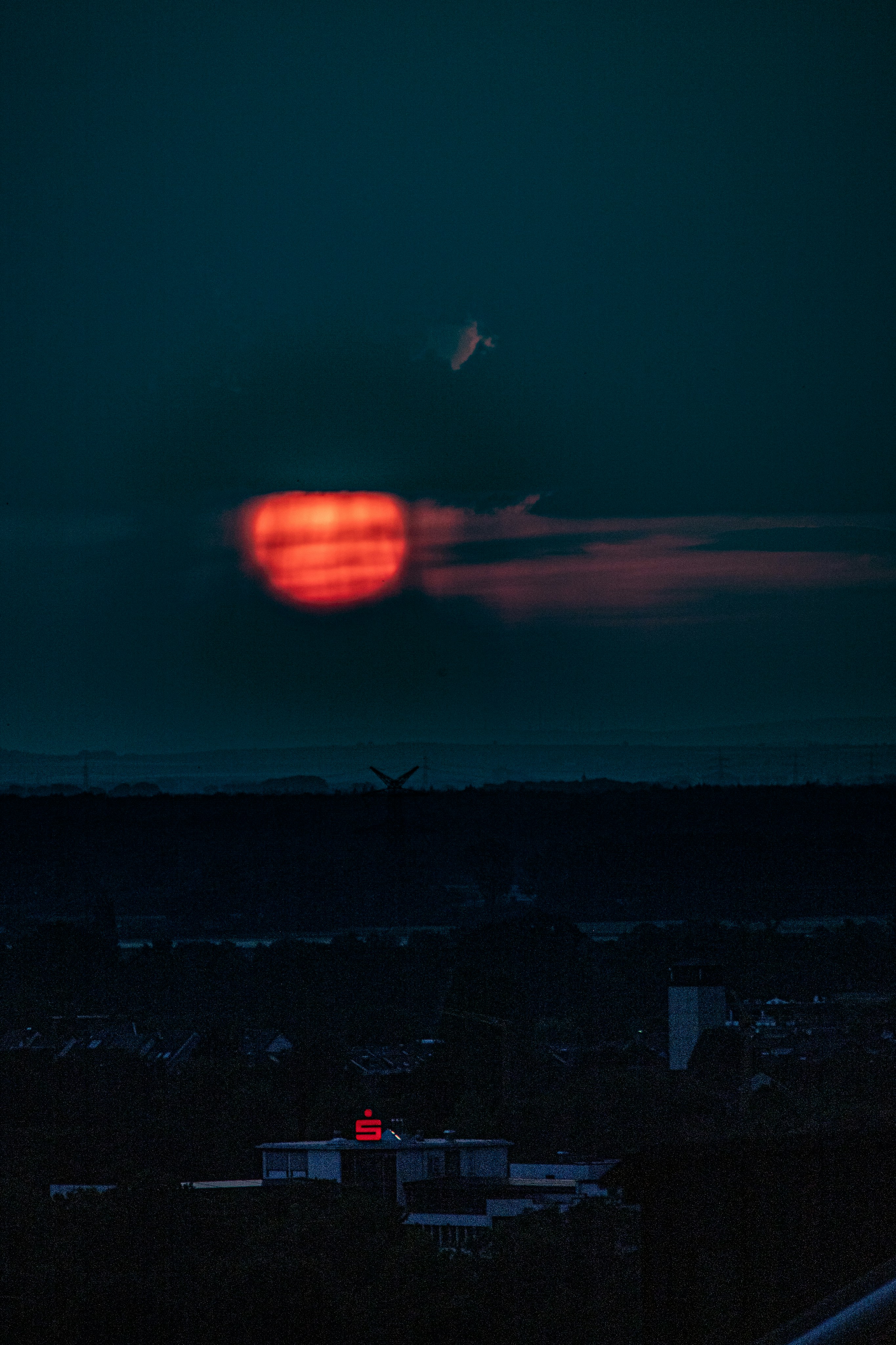 Crimson Sun on a Quiet Horizon