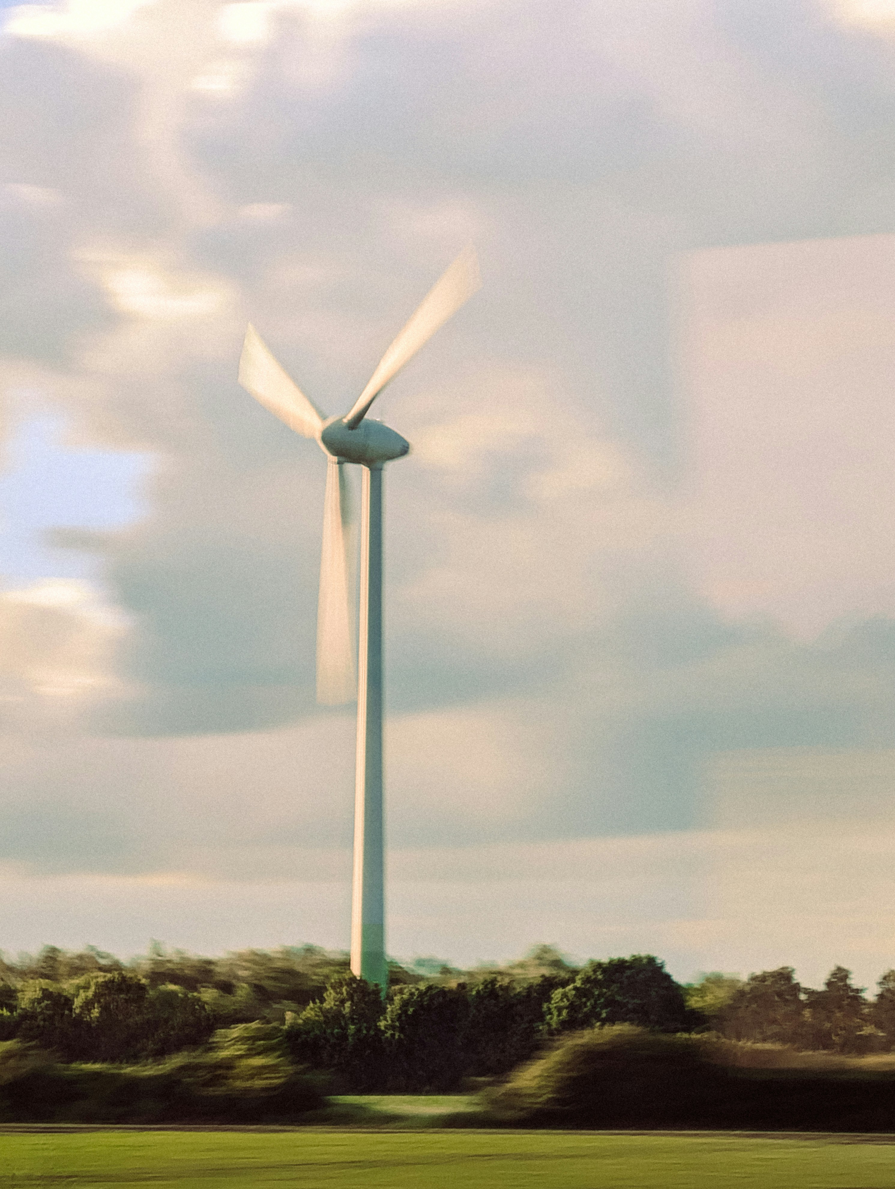 Whispering Giant: A Wind Turbine Amid Soft Haze