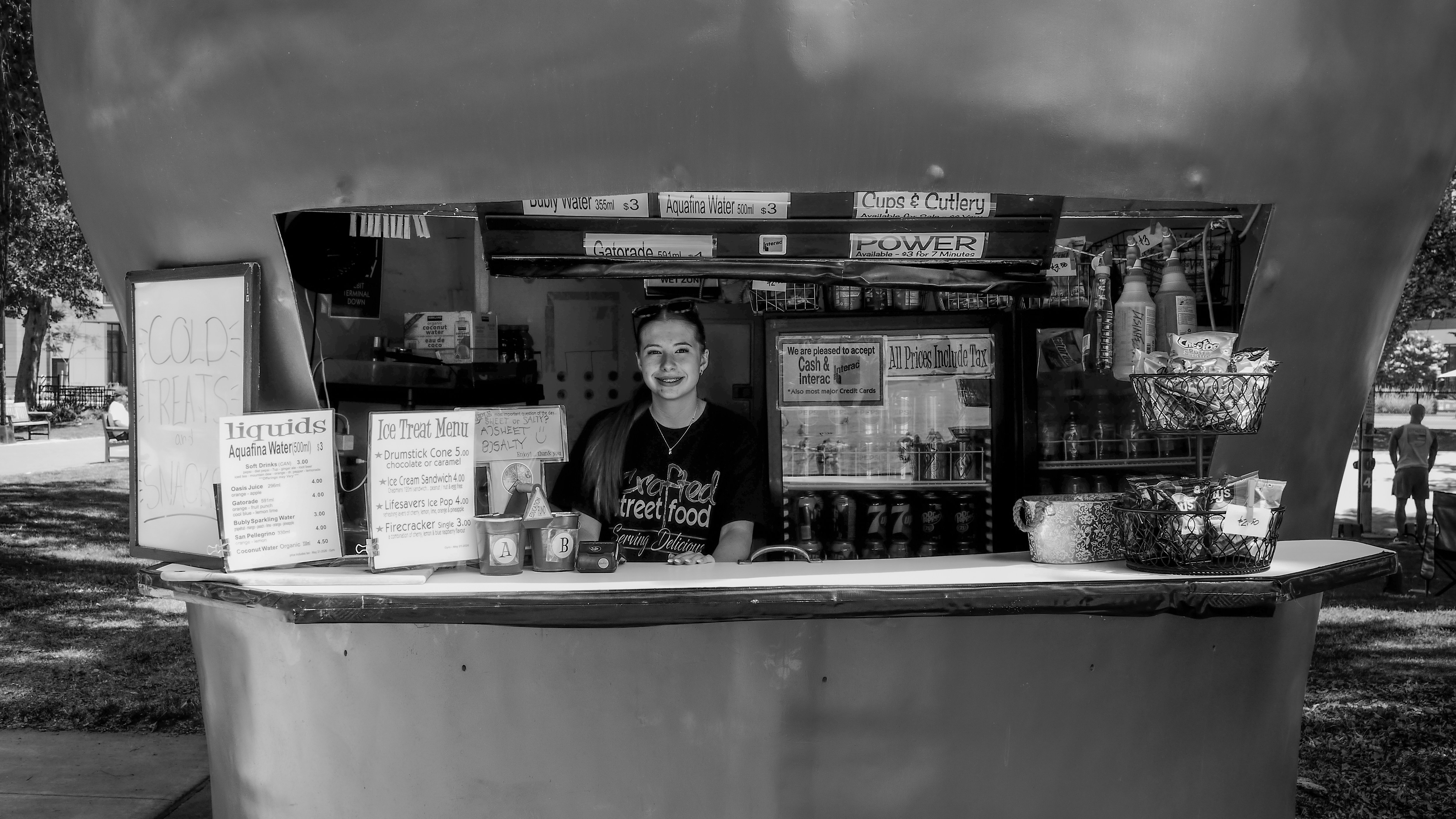 Stand at the Stand: A Friendly Vendor Behind a City Concession Cart