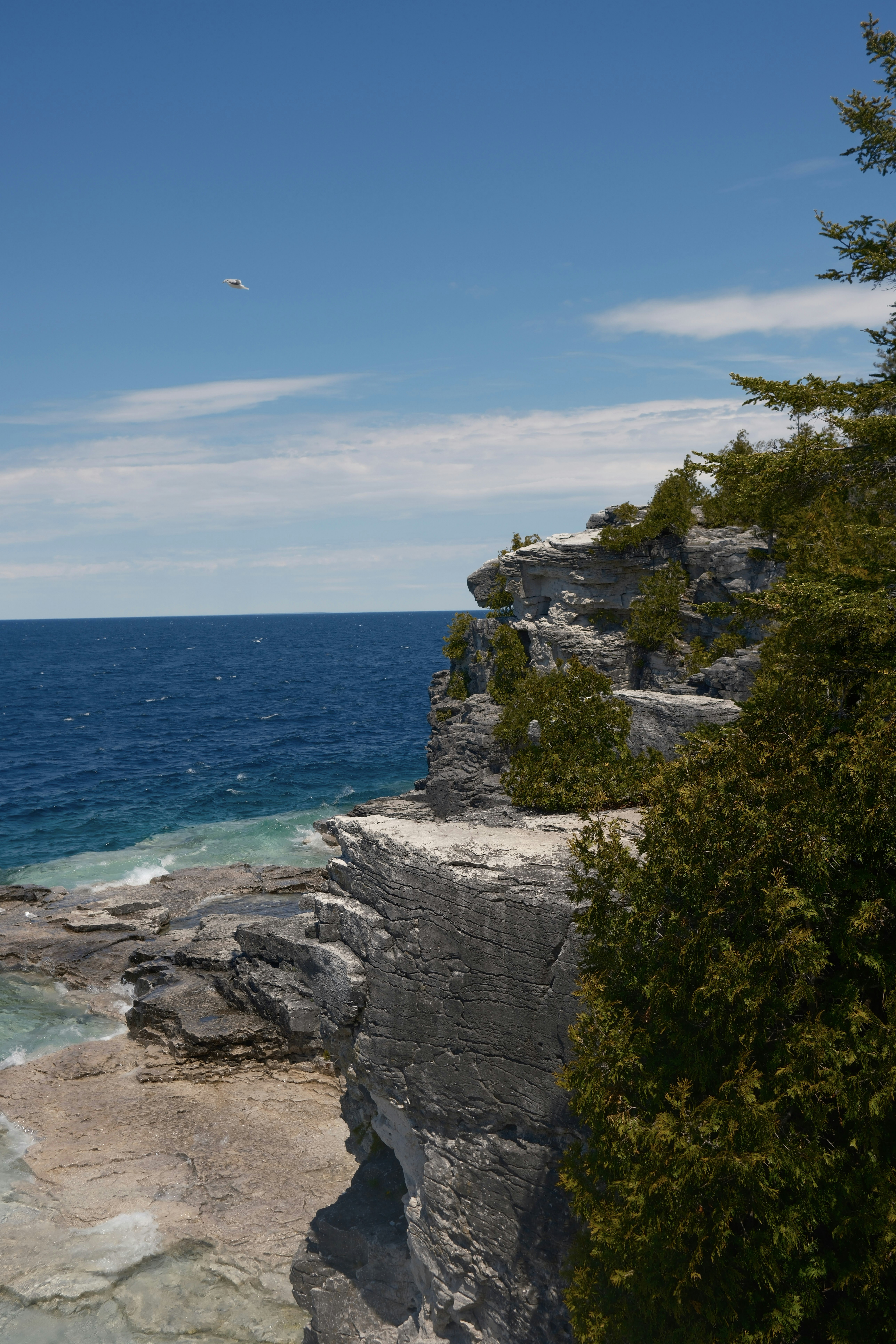 Cliffside Vista over Turquoise Sea under Blue Sky