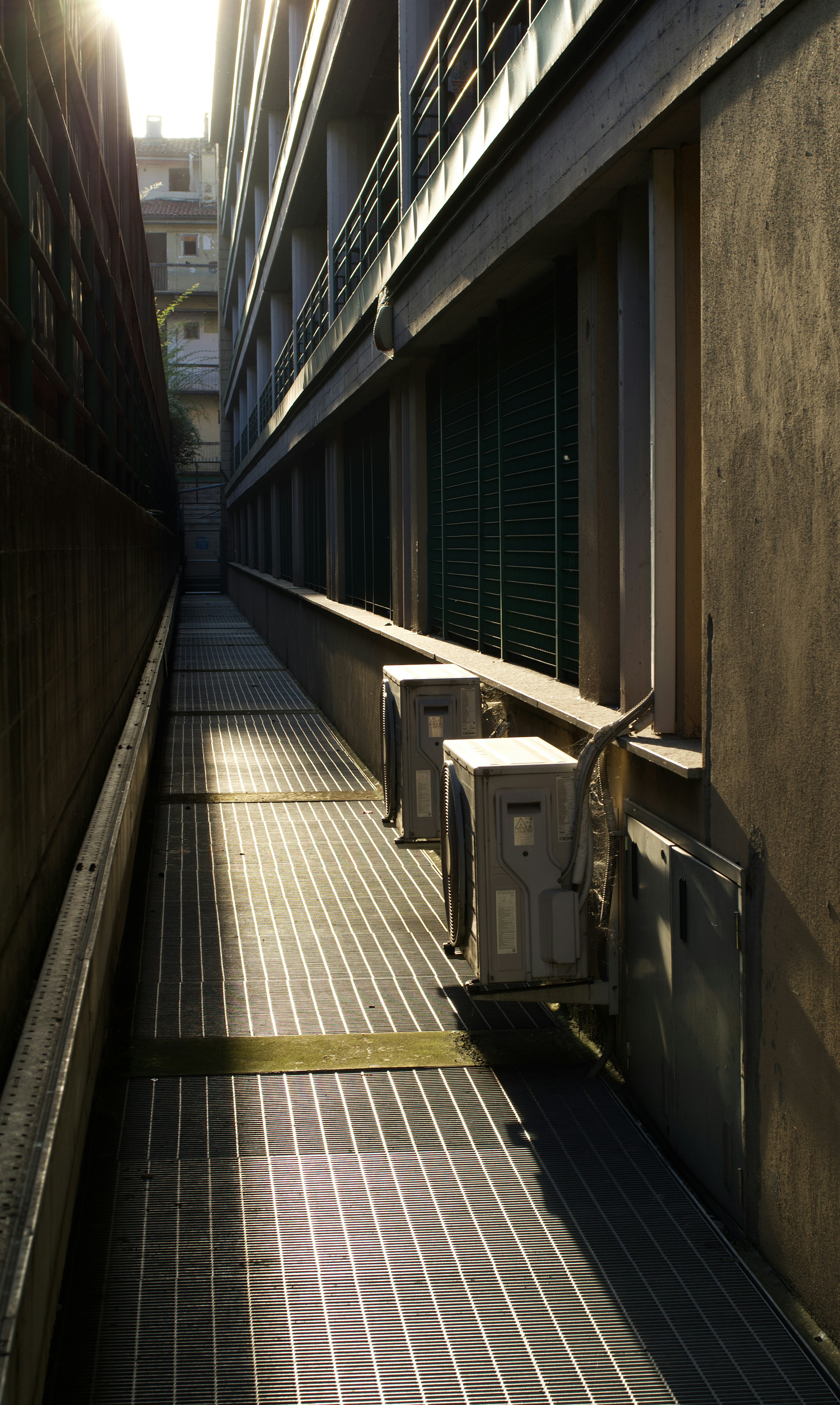 Sunlit Corridor of Steel Grates