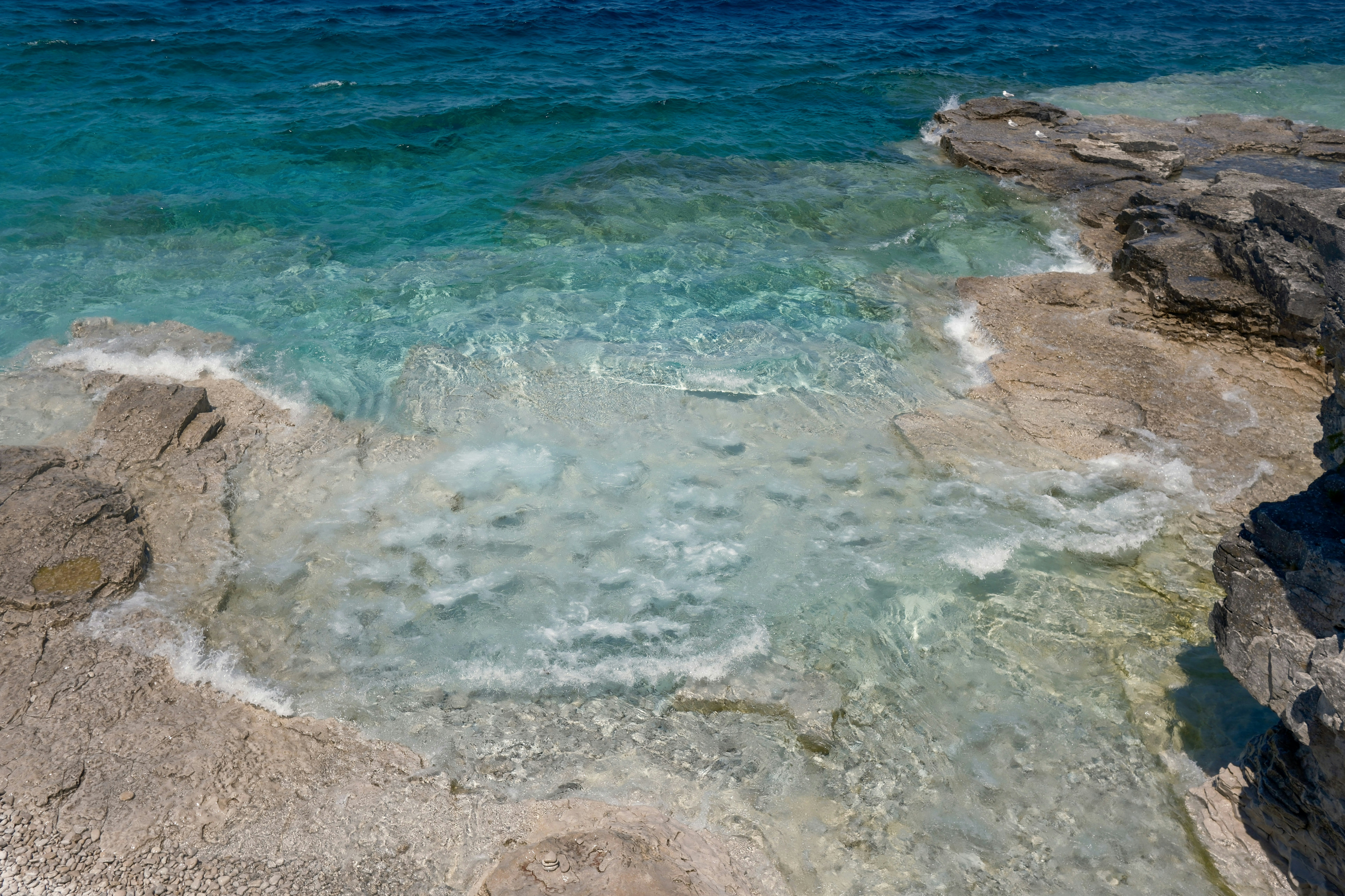 Turquoise Tide Touching Sunlit Stone