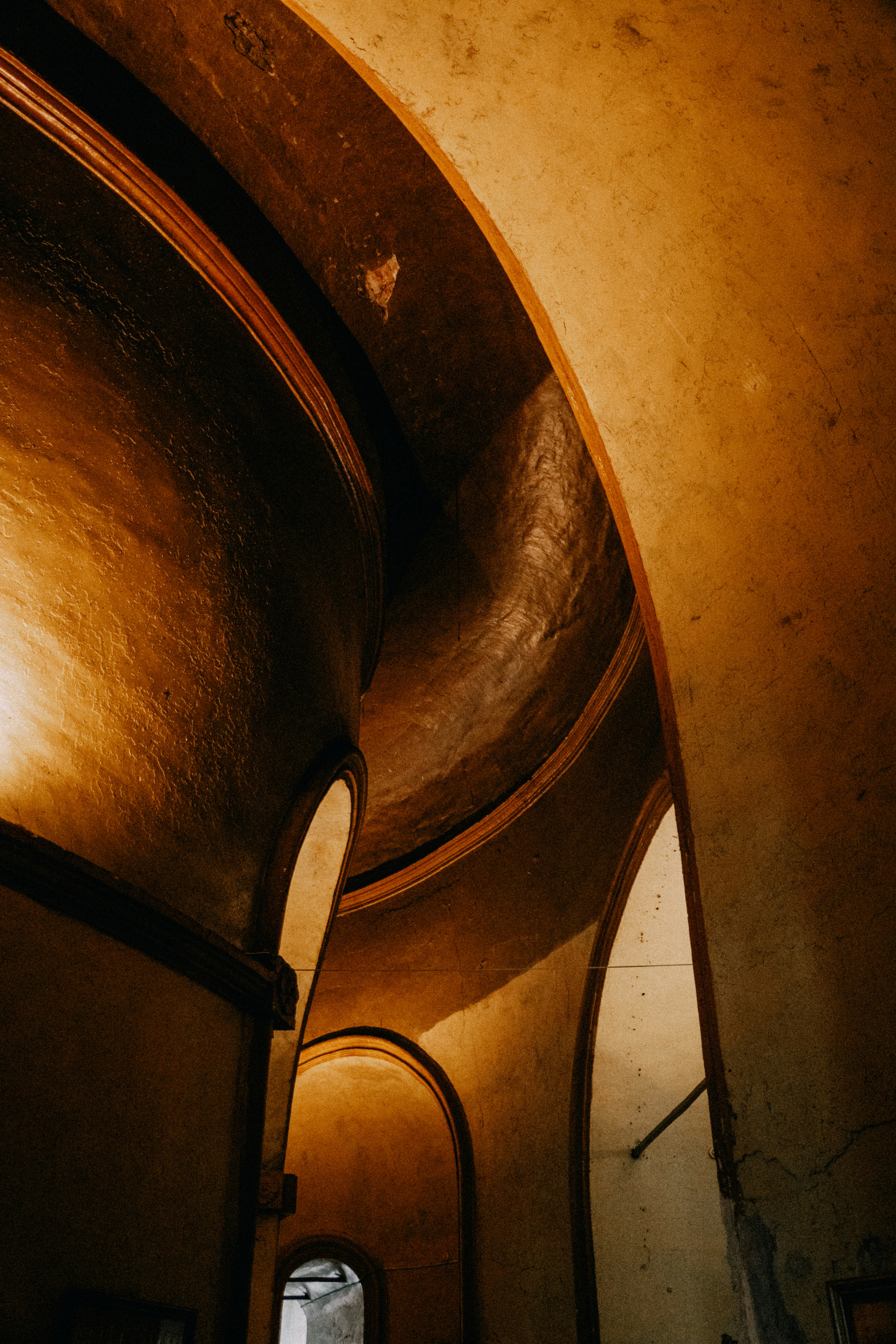 Archway of Warm Echoes: A Curved Staircase in Amber Light