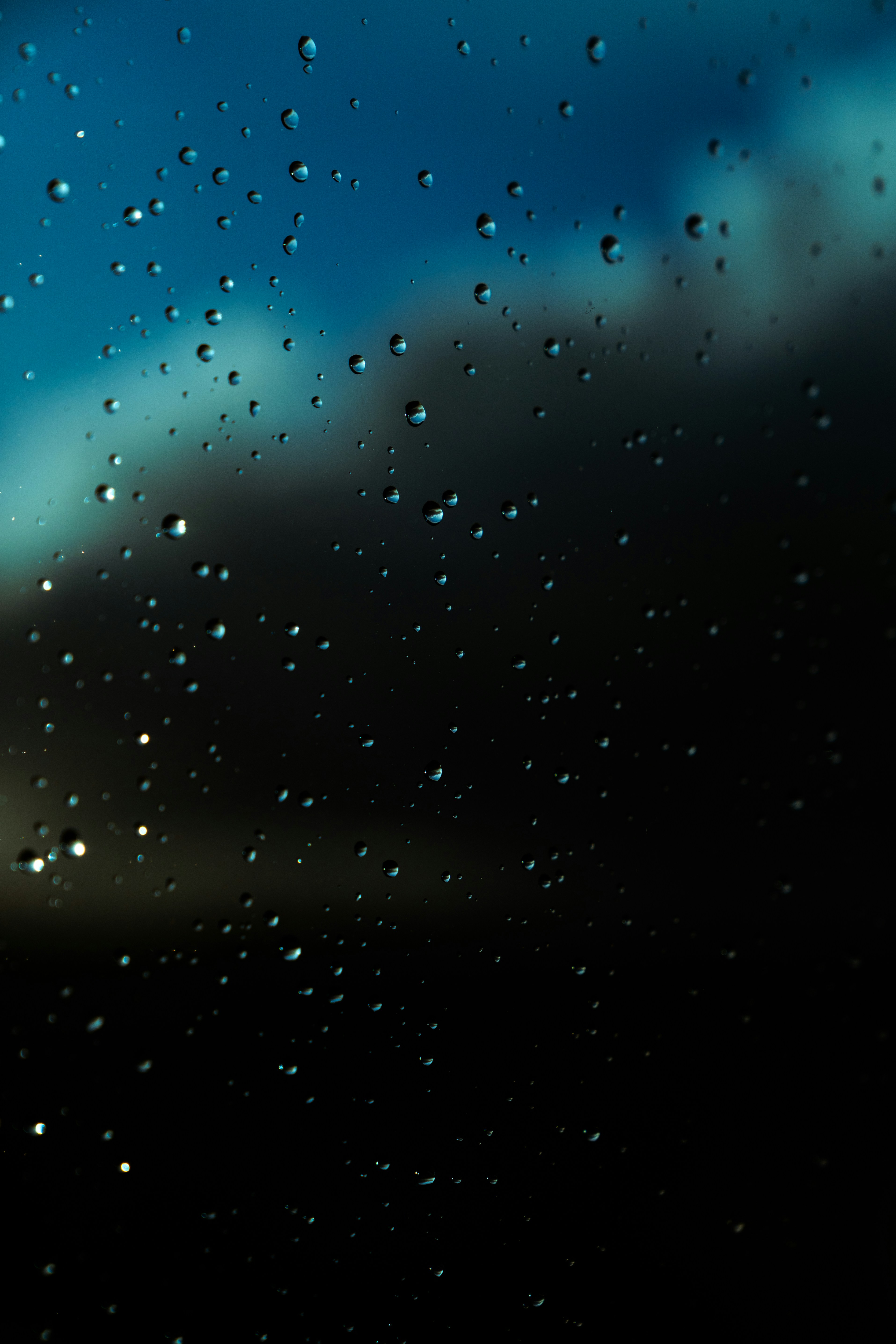 Rains of Color: Abstract Blue-Bokeh Across a Dim Horizon
