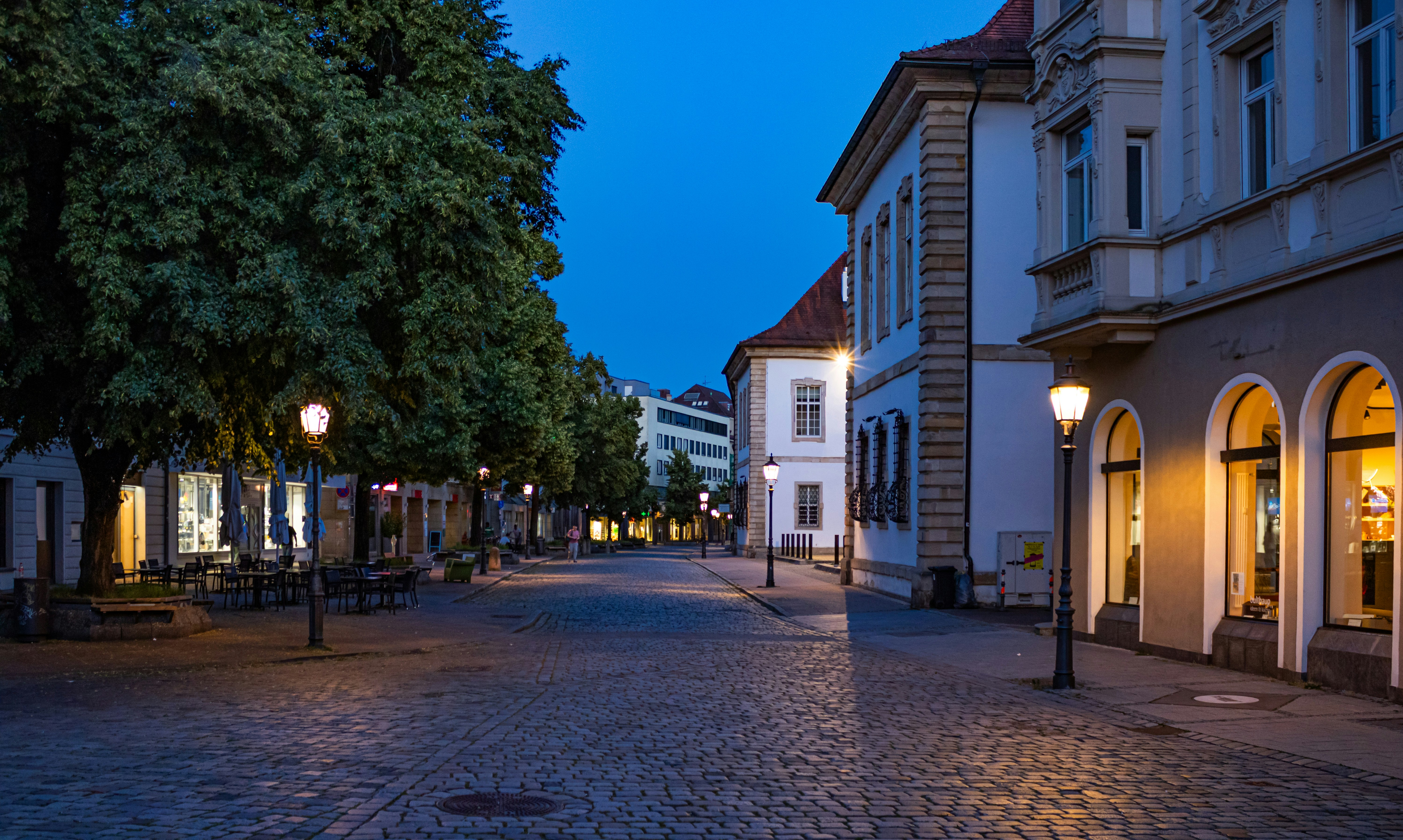 Cobbled Street at Blue Hour with Warm Shopfronts