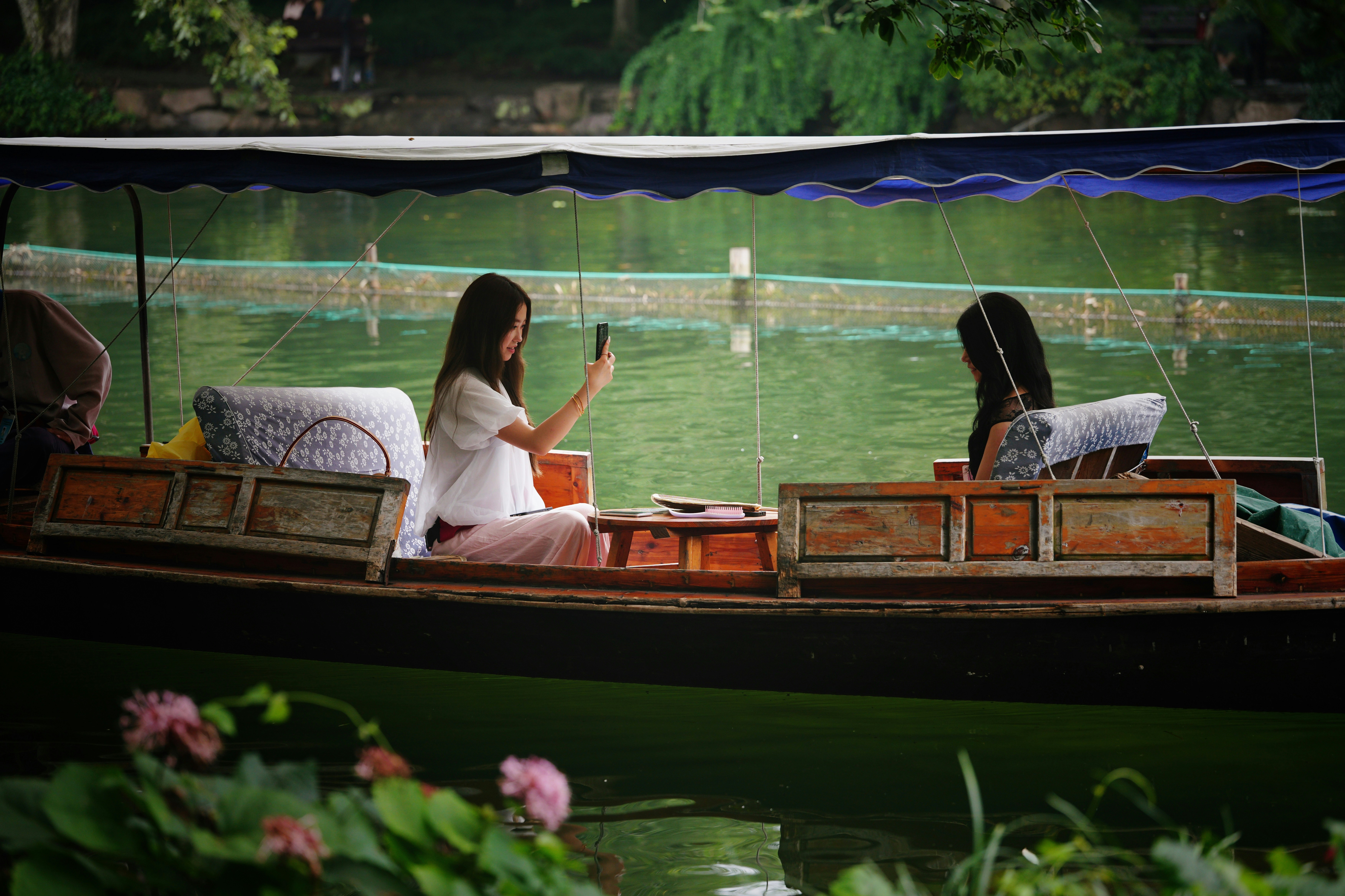 Quiet Conversation Afloat: A Moment of Connection on a Riverside Boat