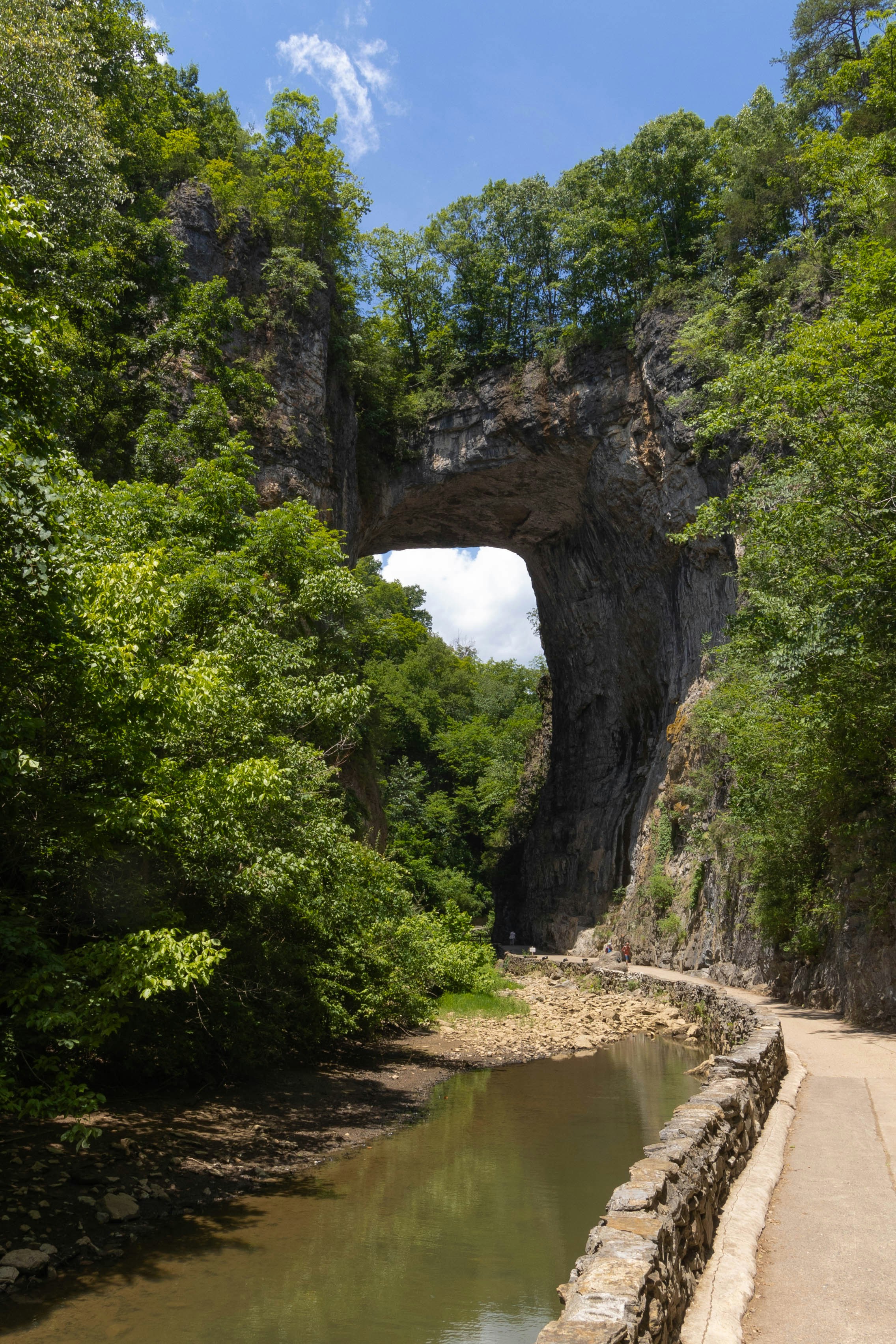 Stone Archway Carved by Time Over a Quiet Channel