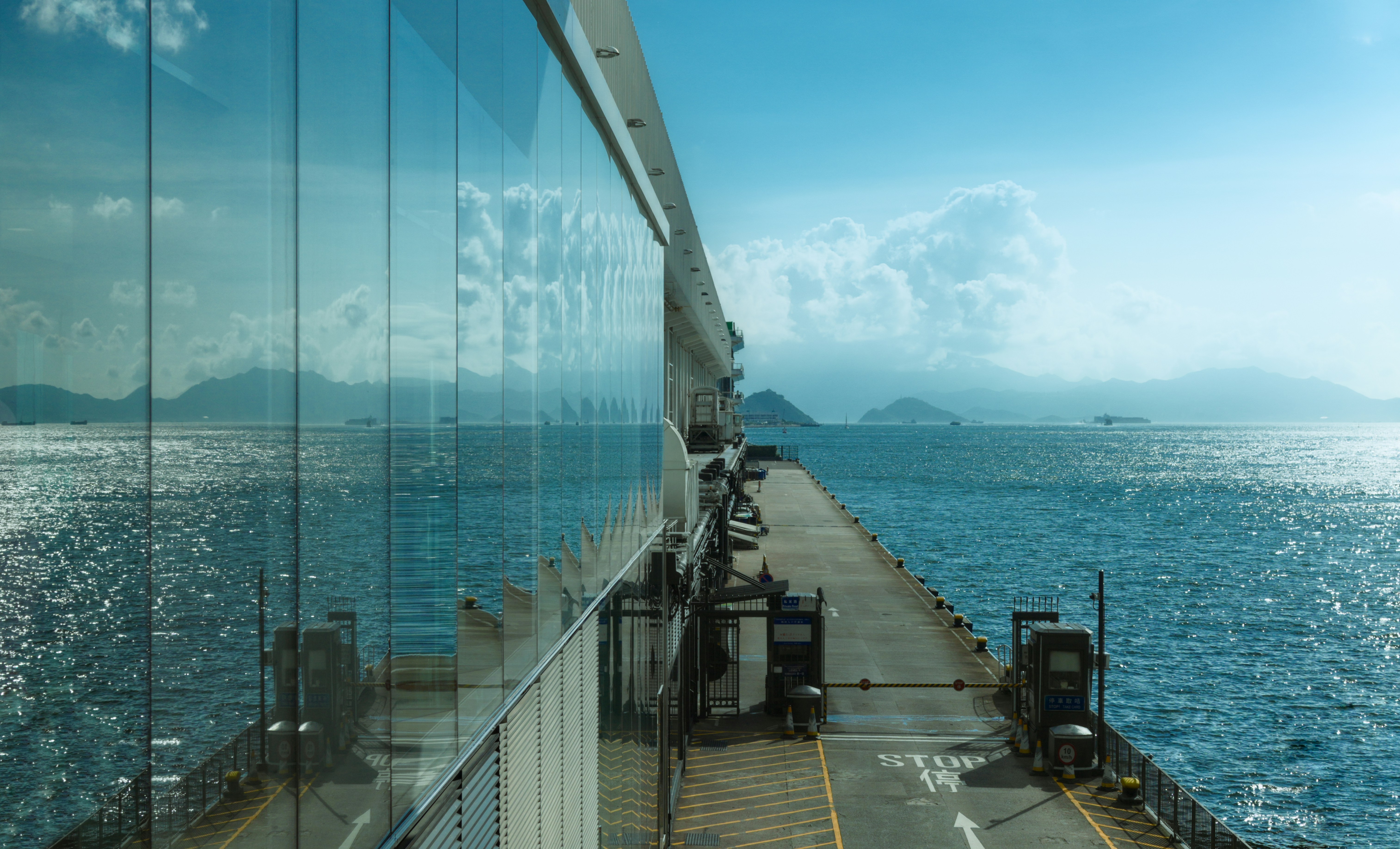 Glass Horizon: Pier Reflections Along a Calm Sea