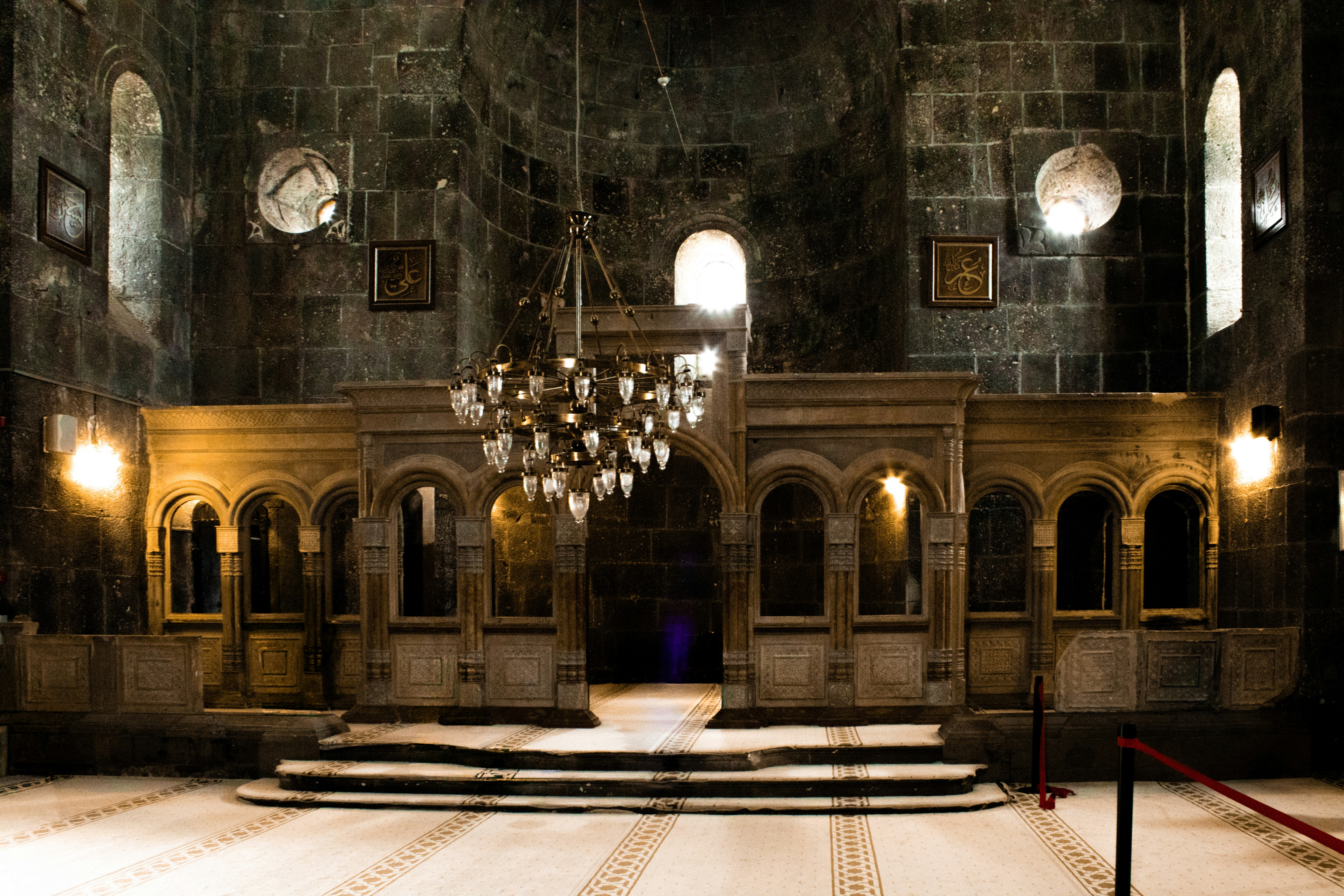 Silent Hall of Arches: A Dimly Lit Cathedral Vestibule with Central Chandeliers