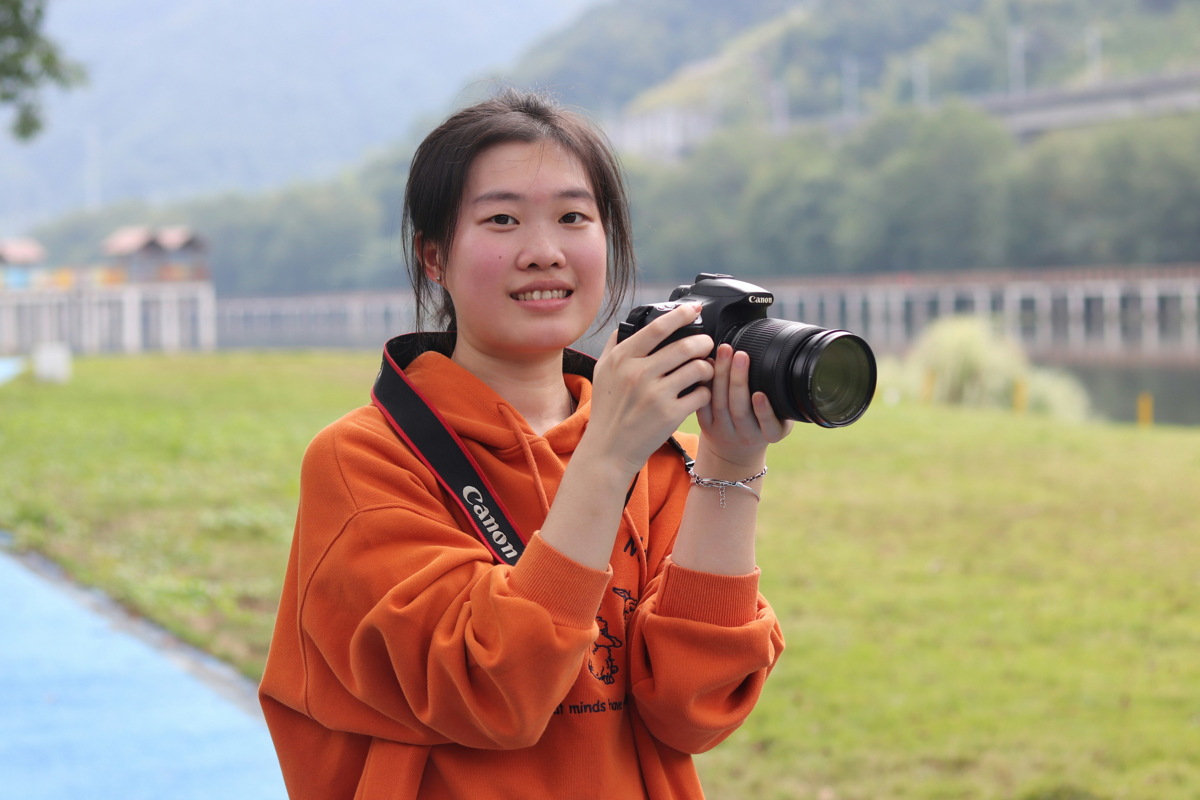 Bright Orange Hoodie, Focused on a Young Photographer in the Field