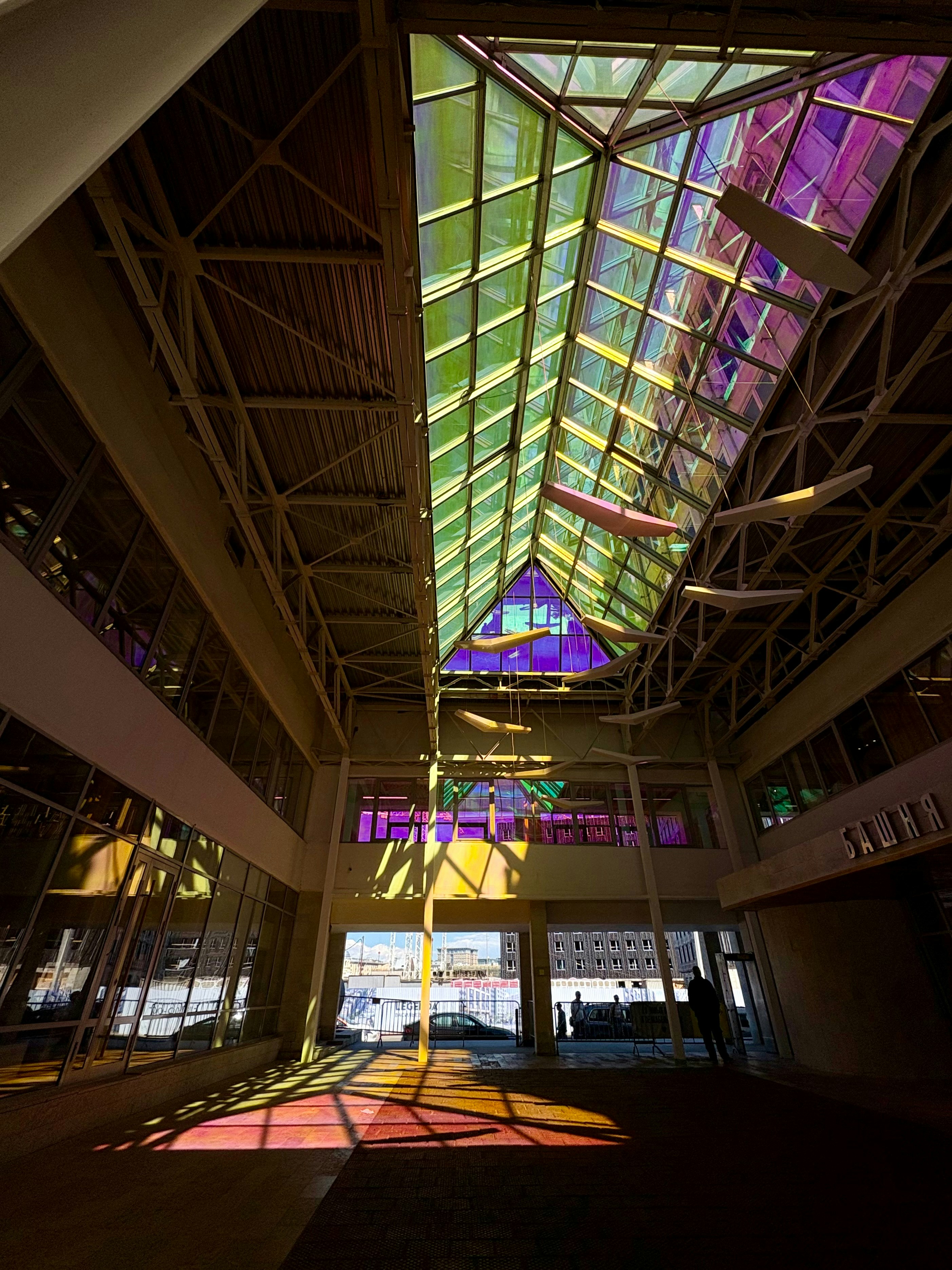 Colored Atrium Bloom: Light Shards in a Glass Cathedral