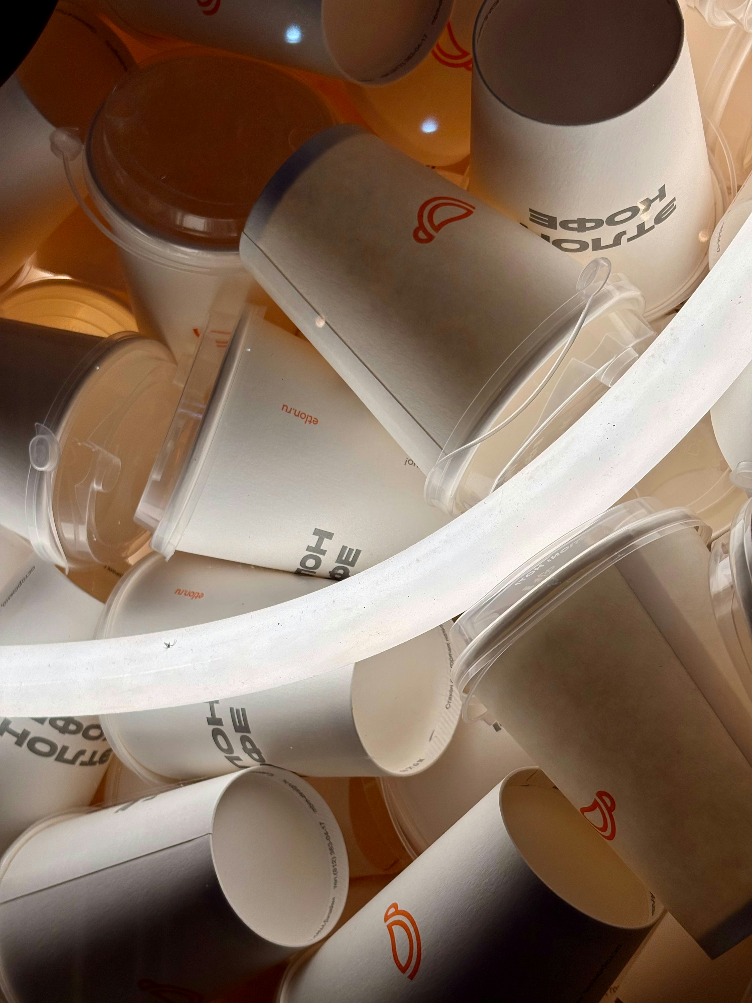 Capsule Confetti: A Tumble of Disposable Cups in a Bright Chaos