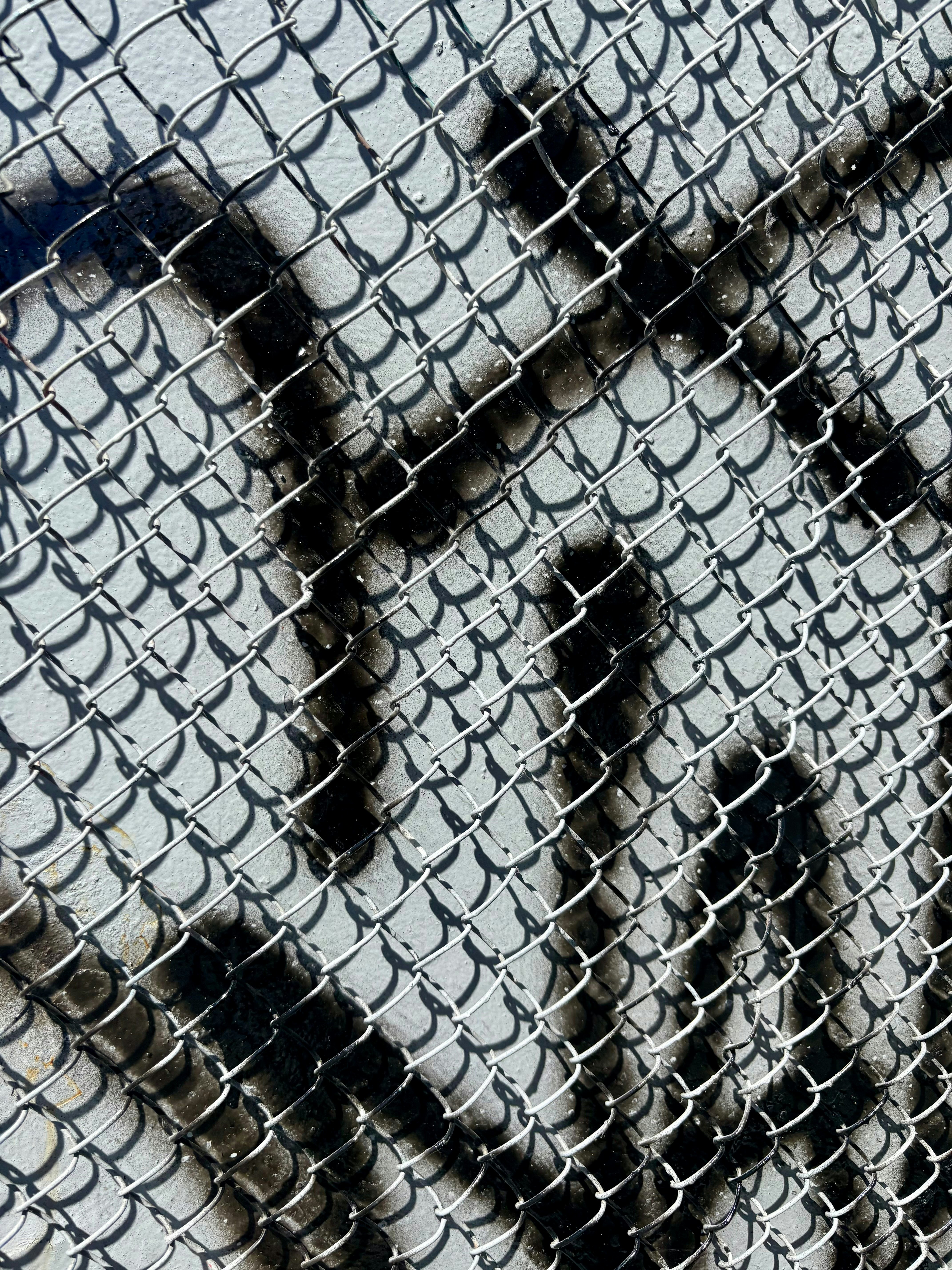 Entangled Mesh: A Close-Up of Weathered Chain-Link Patterns