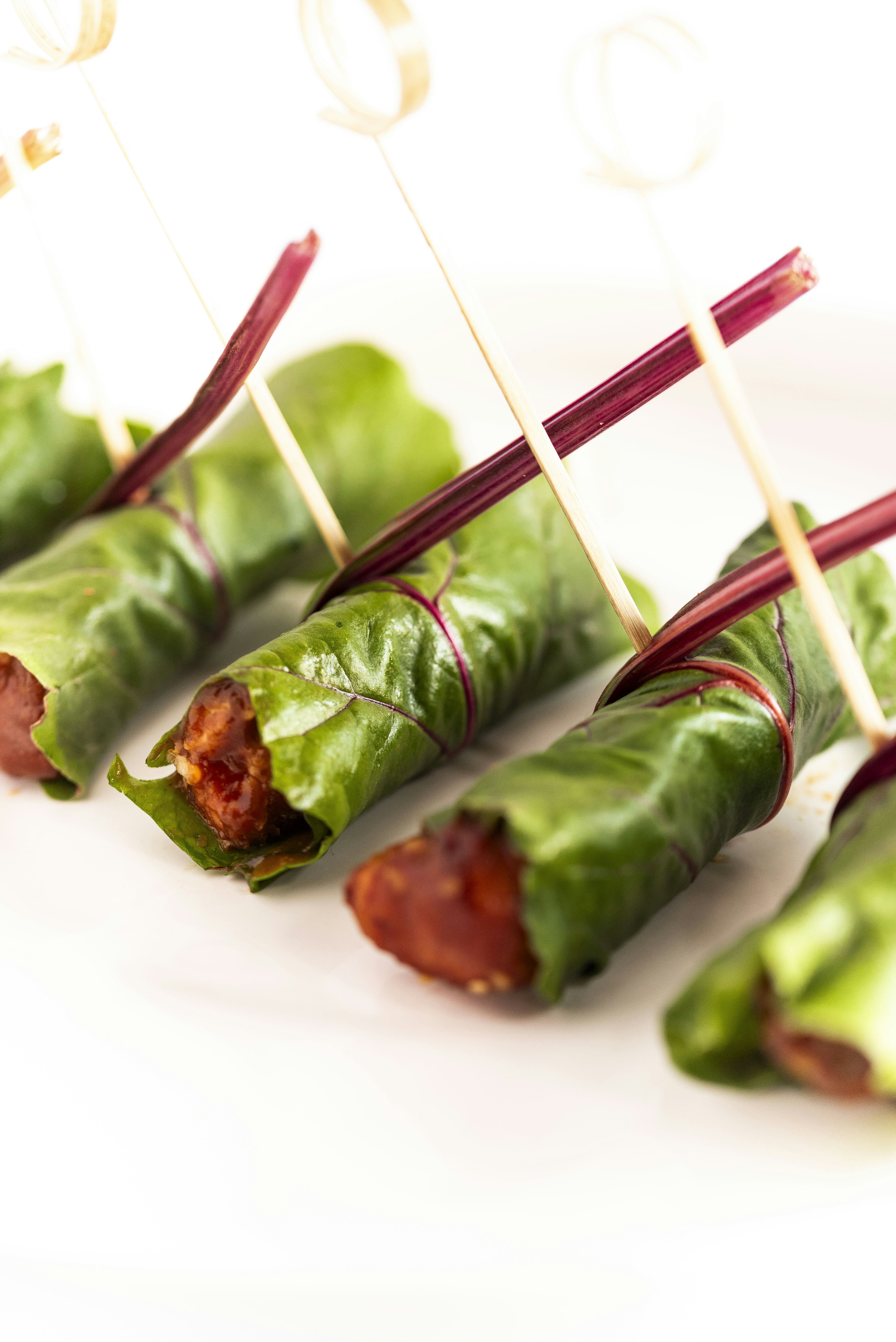 Scrolls of Flavor: Beet-Stem Rolls on a Clean White Stage