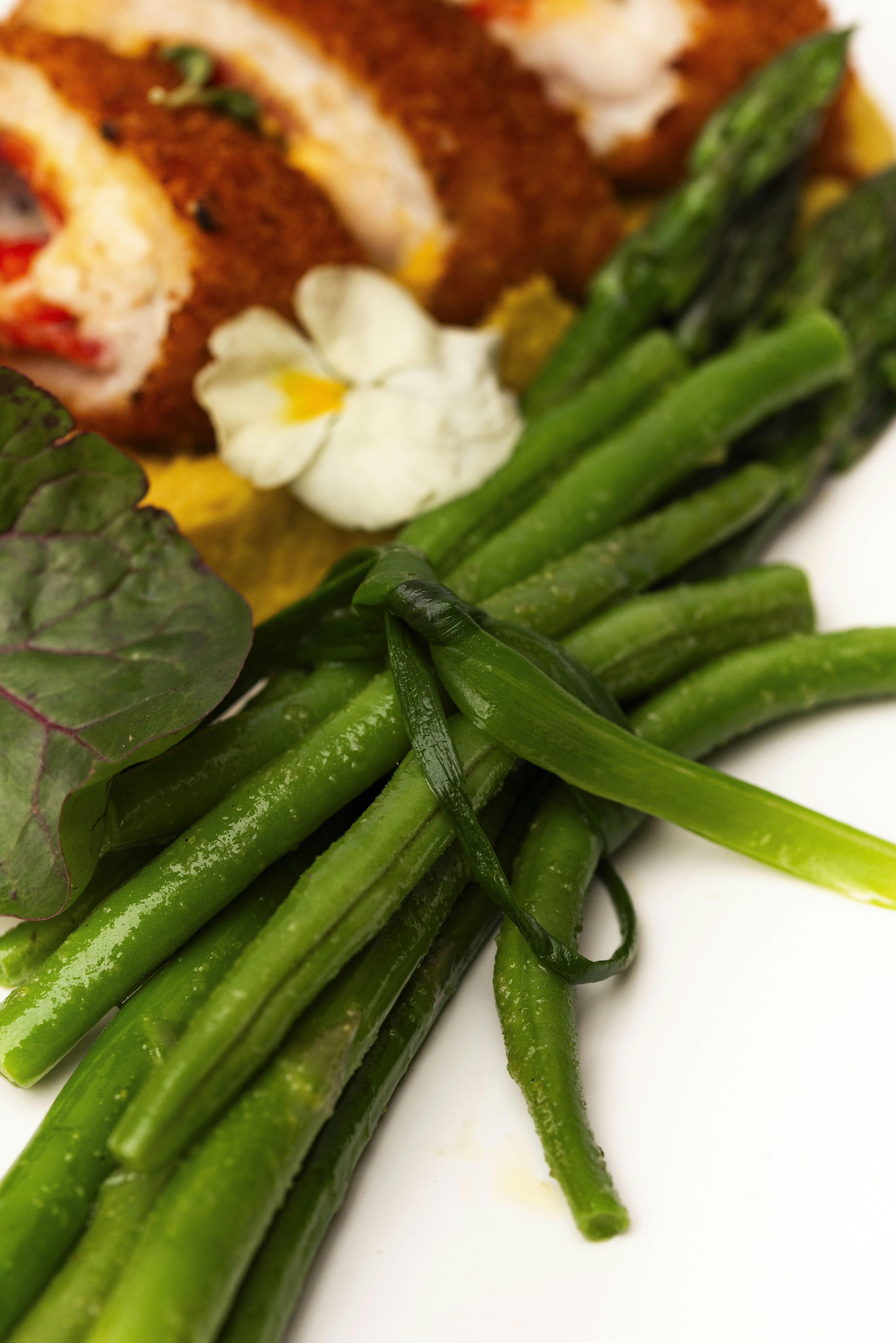 Green beans and crispy bites: a plate resting on a vivid spring green