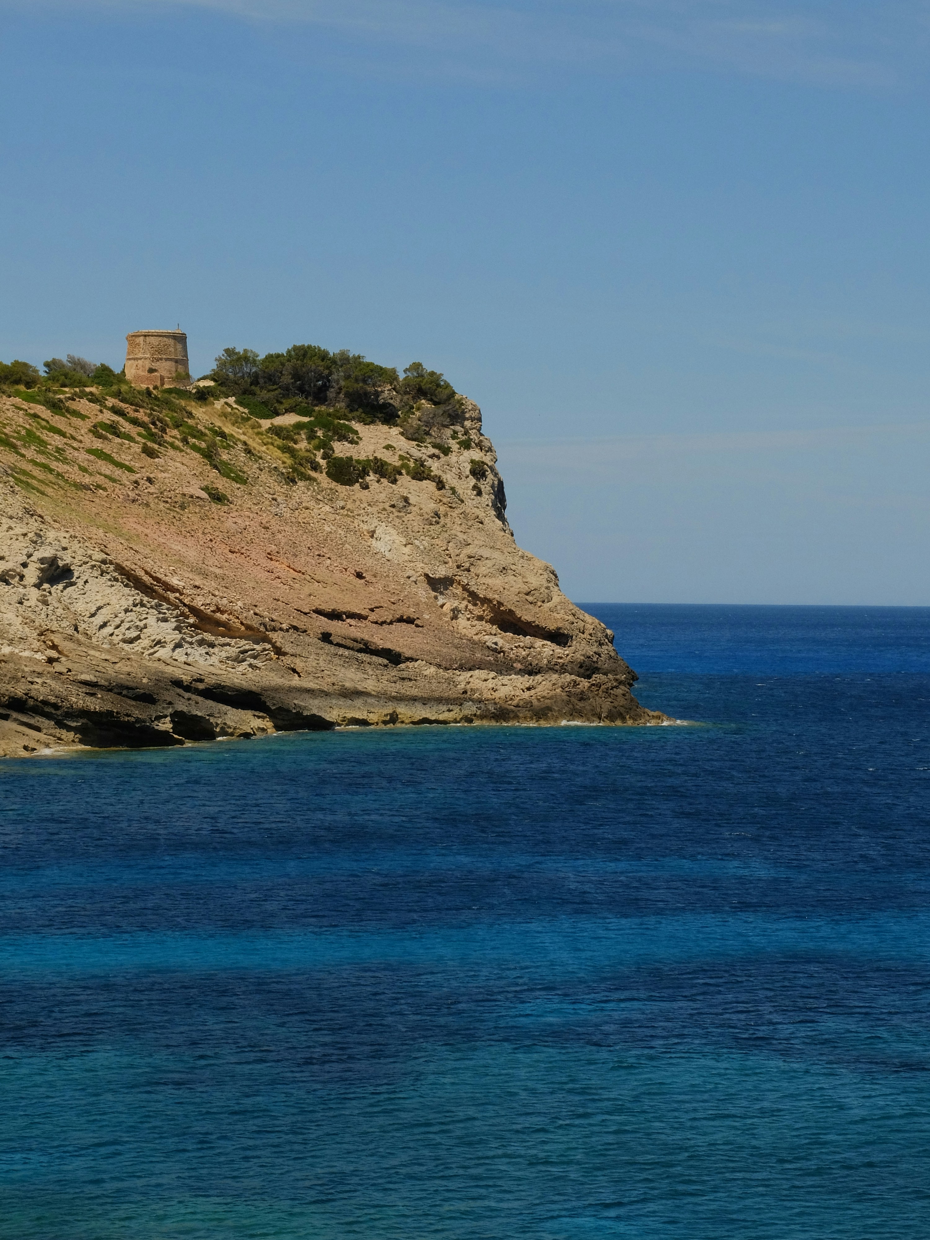 Cliffside Beacon Over Blue Waters
